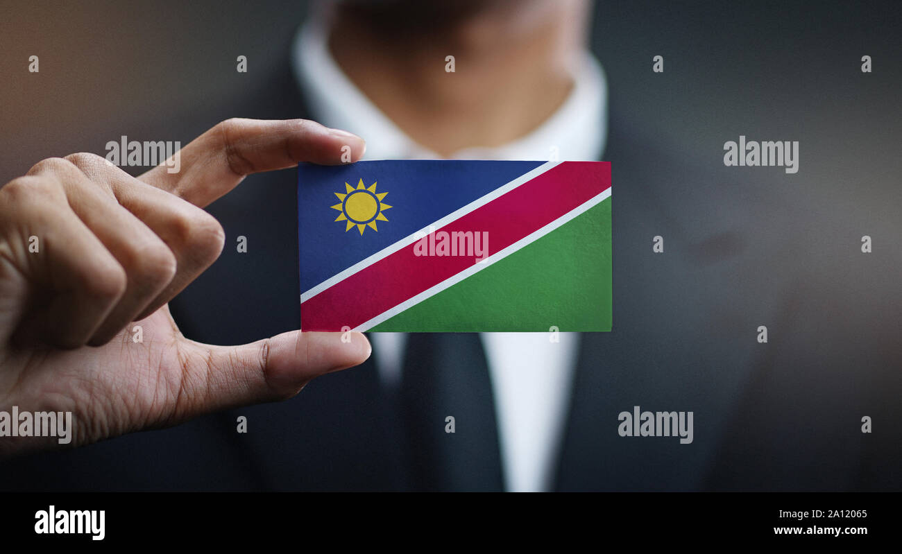 Businessman Holding Card of Namibia Flag Stock Photo - Alamy
