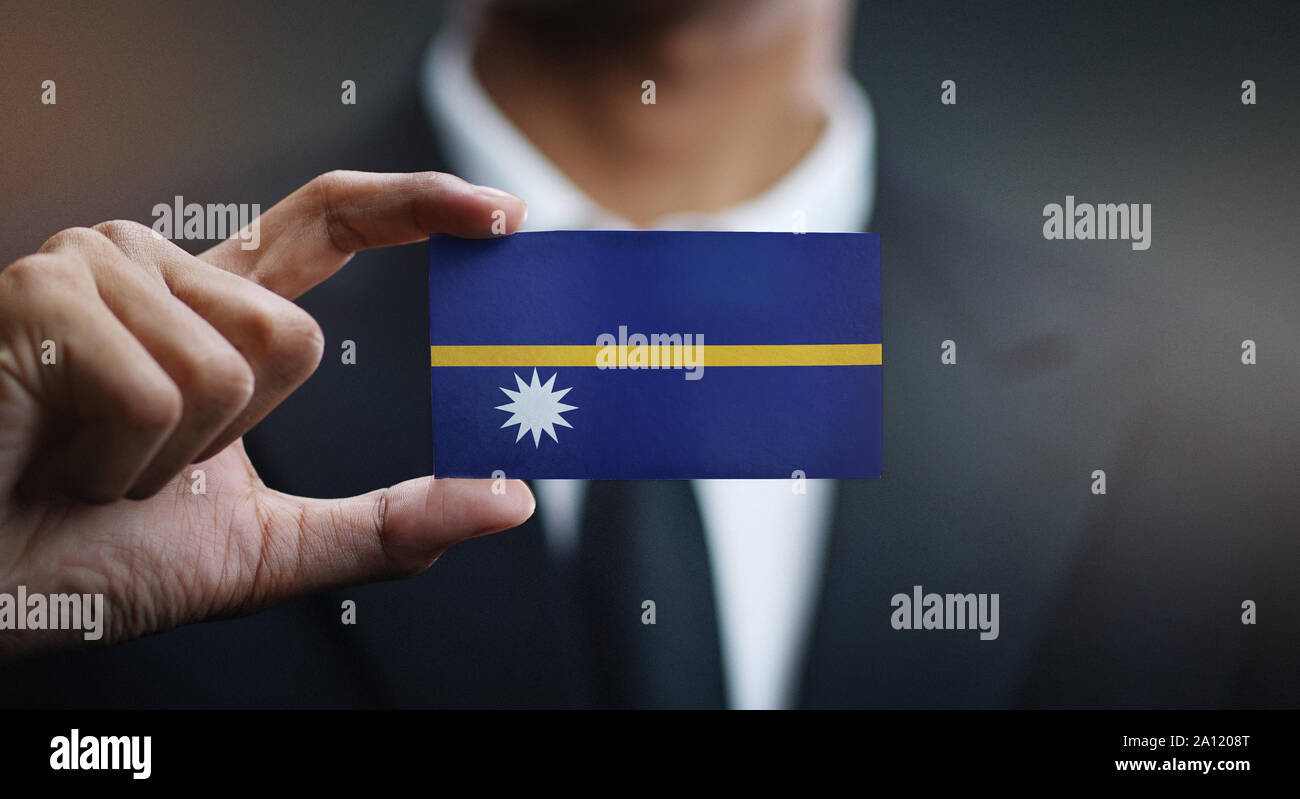 Businessman Holding Card of Nauru Flag Stock Photo - Alamy