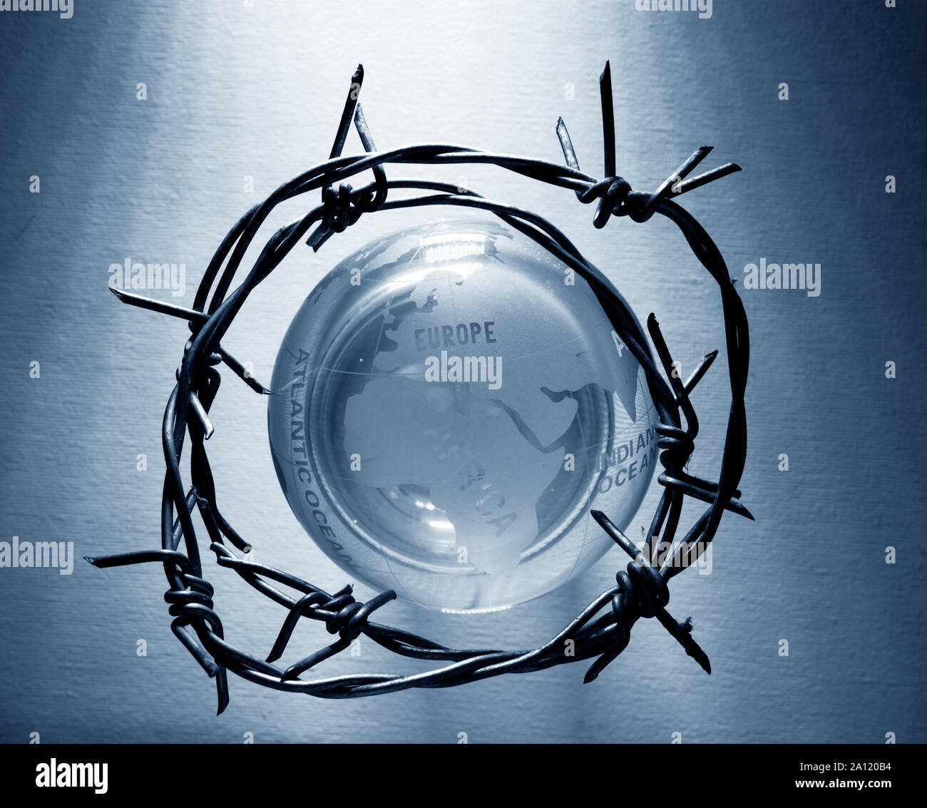 Globe and barbwire depicting global problems and crisis Stock Photo - Alamy