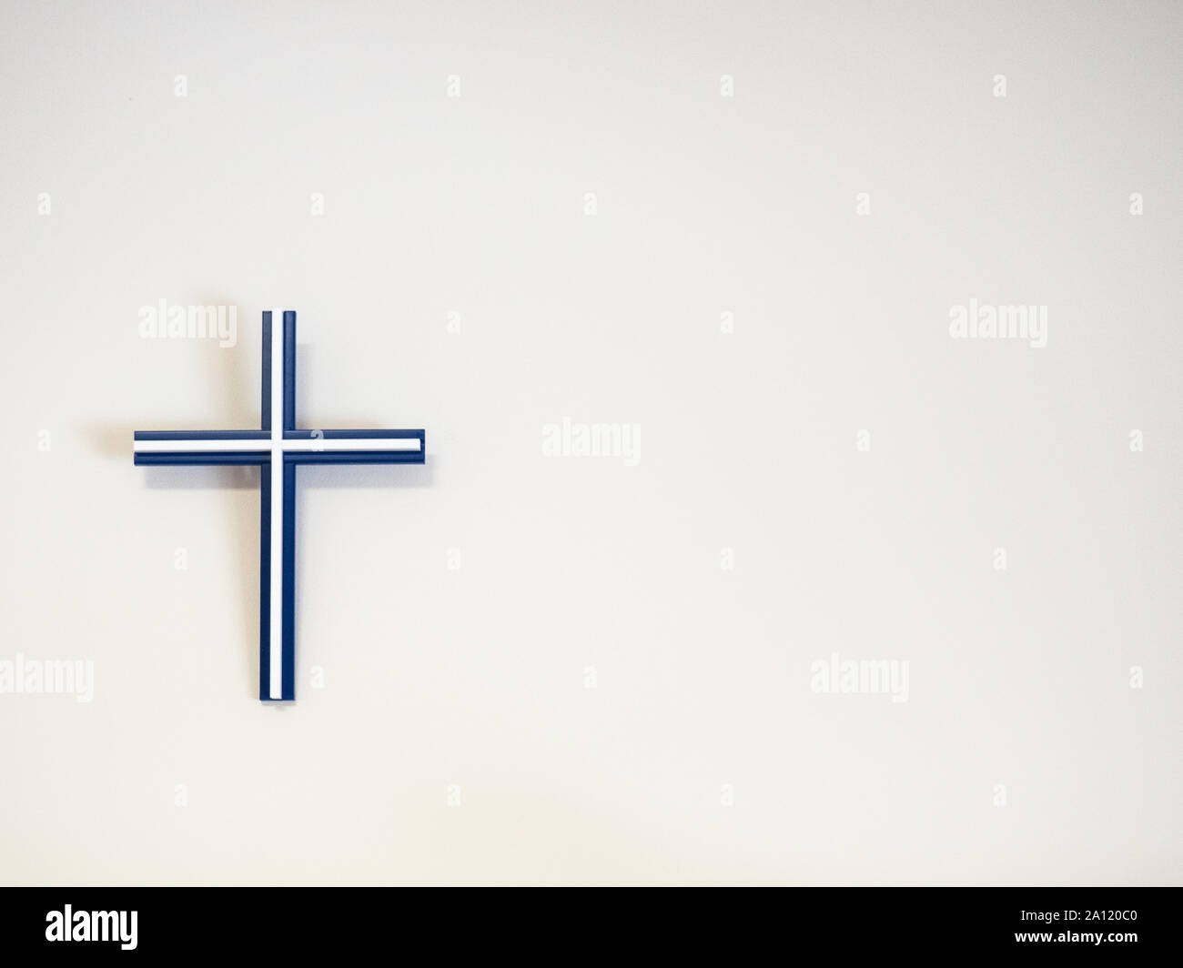 Blue and white catholic cross on a wall with copy space Stock Photo - Alamy