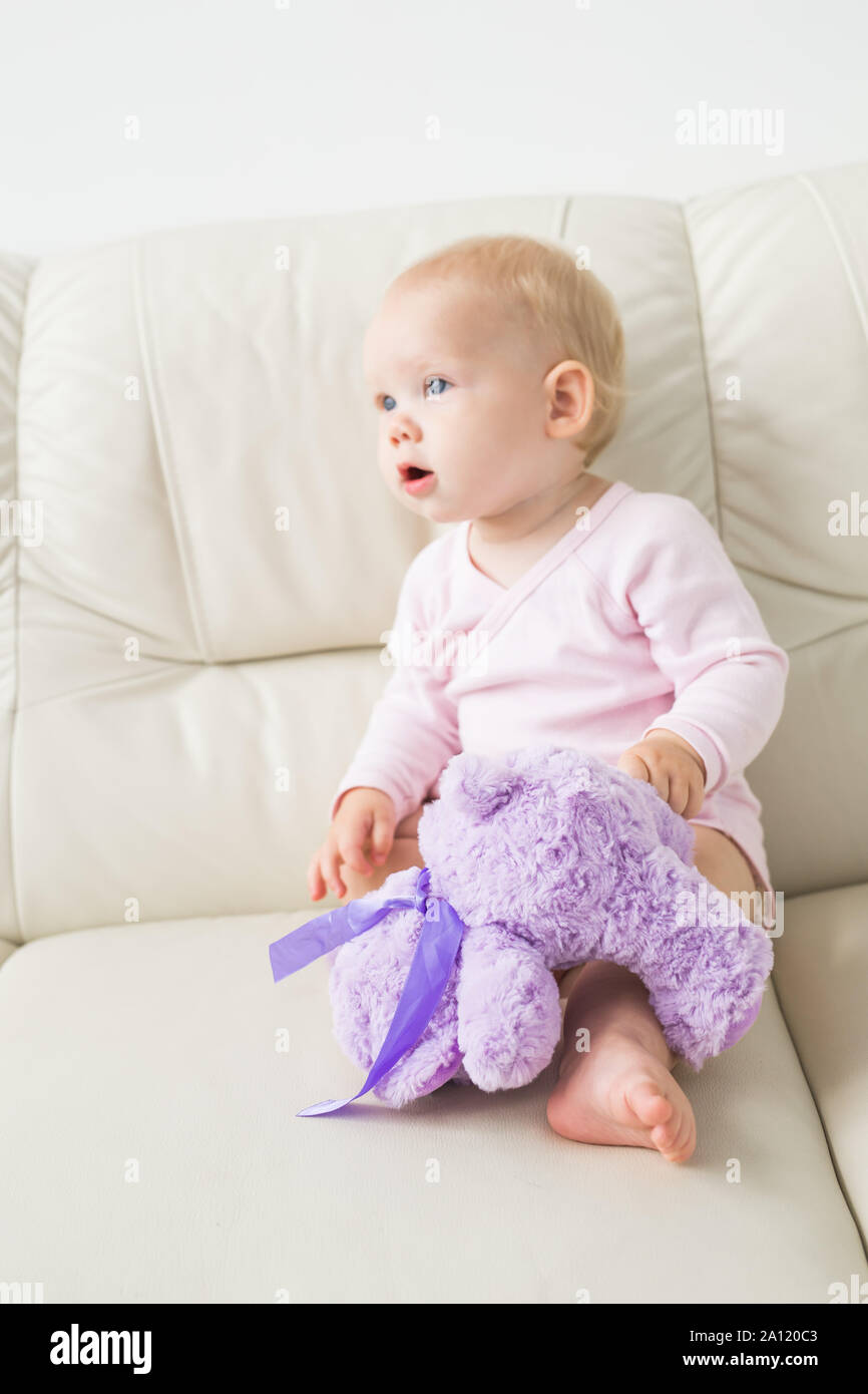 childhood, babyhood and people concept - happy little baby girl sitting ...