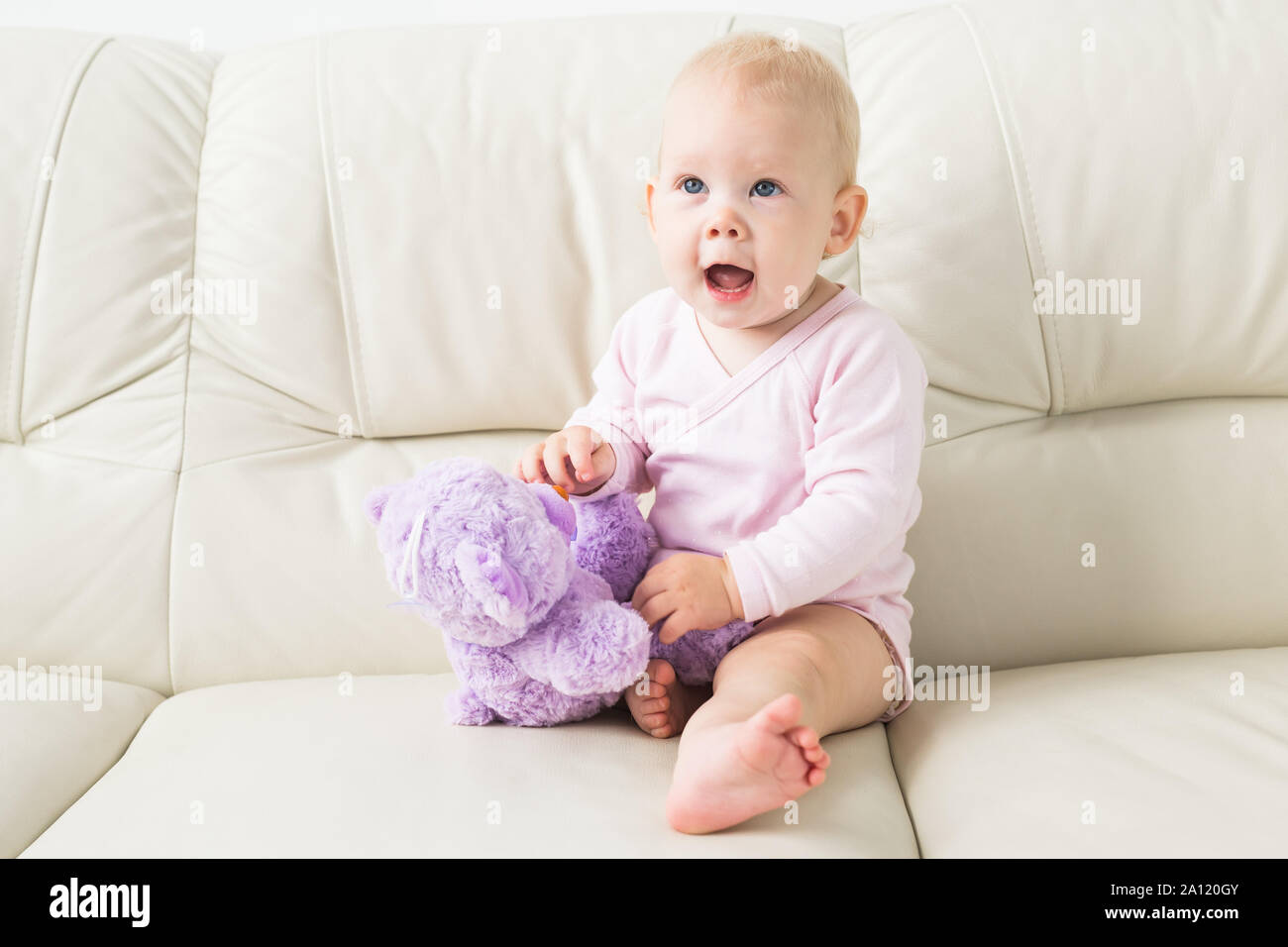 childhood, babyhood and people concept - happy little baby girl sitting ...