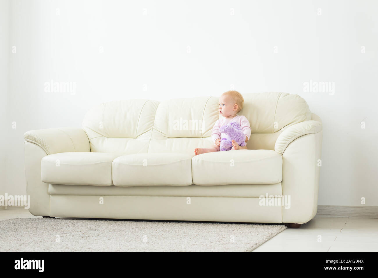 childhood, babyhood and people concept - happy little baby girl sitting ...