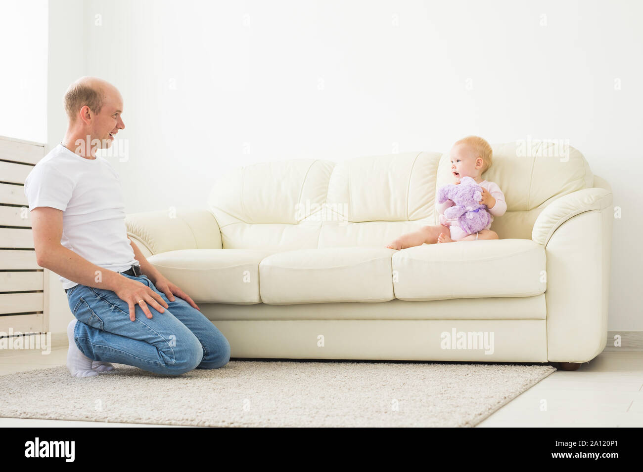 family, parenthood and fatherhood concept - happy father playing with ...