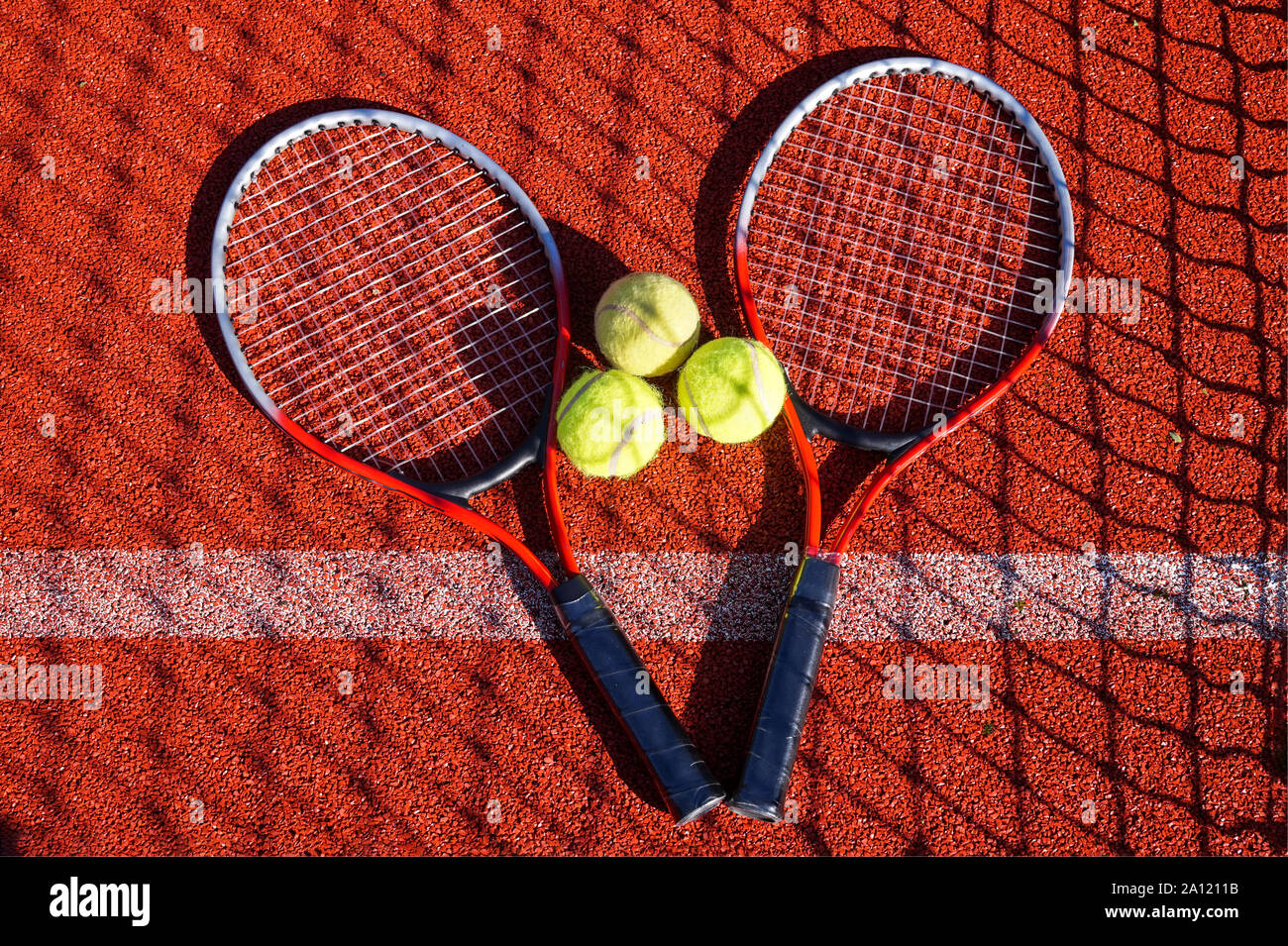 Top view tennis scene with balls, racquets, net shadow and hard court ...