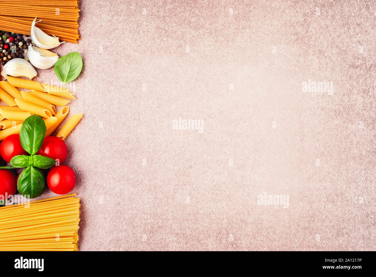 Pasta ingredients border on light rustic background with copy space ...