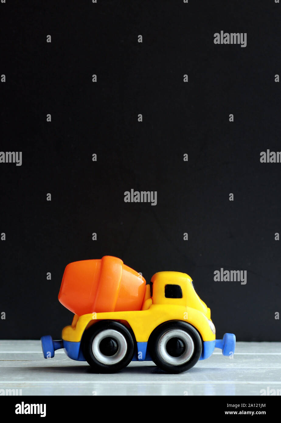 Colorful plastic concrete mixer against black background Stock Photo ...