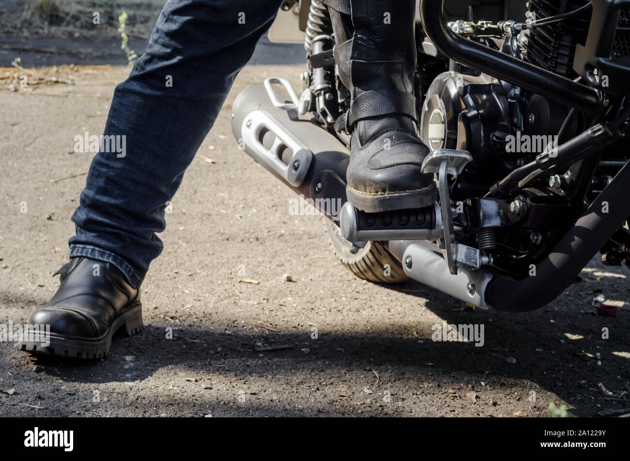 foot bikers in motorcycle boots sitting on a motorcycle Stock Photo - Alamy