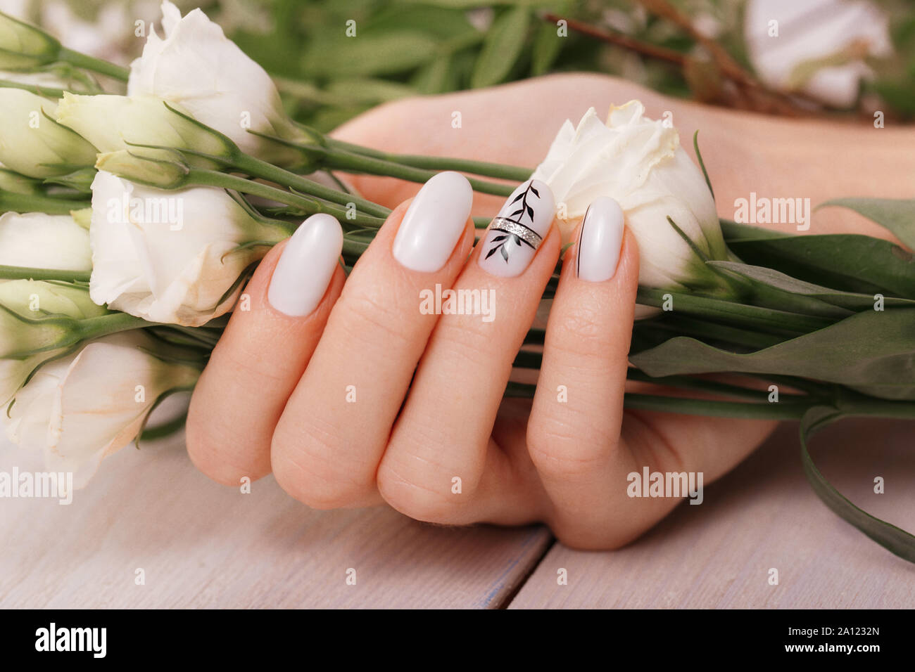 Gentle neat manicure on female hands on flowers background. Nail design ...
