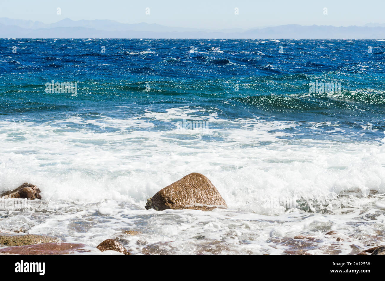 waves and splashes of sea surf and stones on the seashore Stock Photo ...