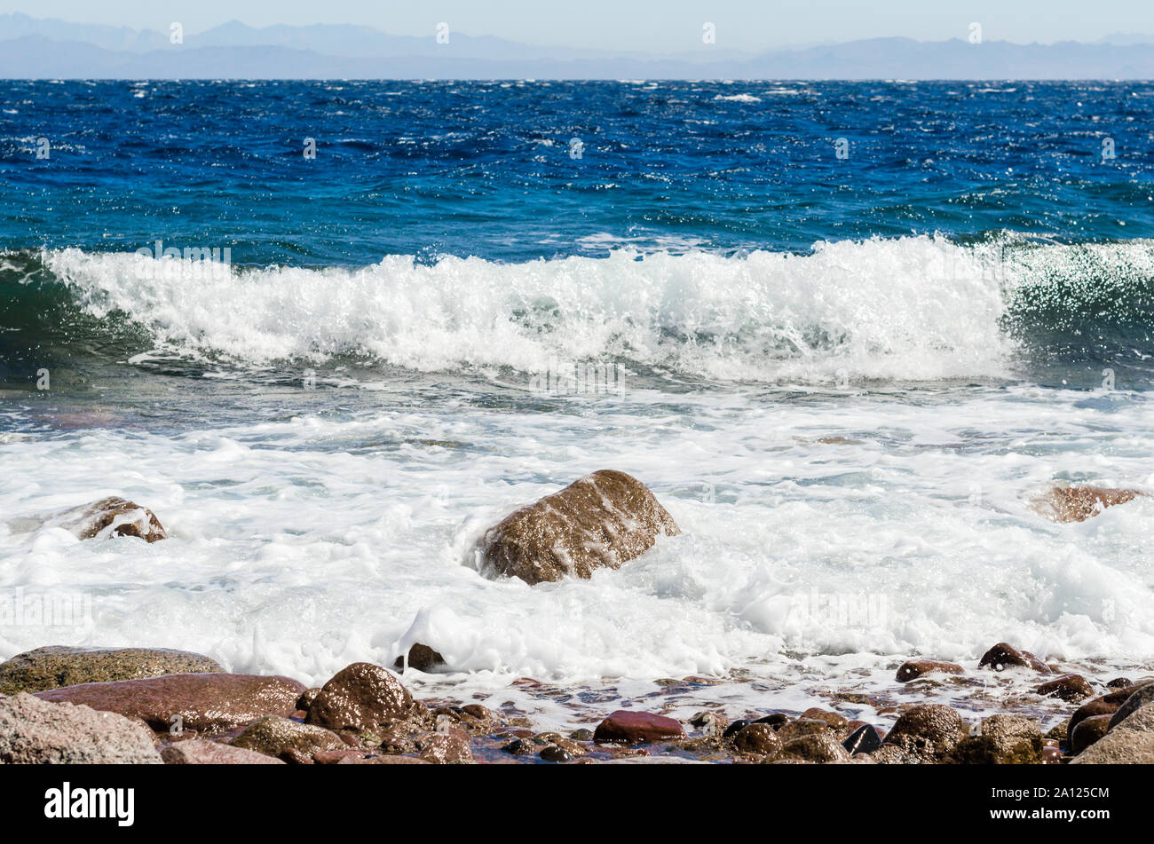 waves and splashes of sea surf and stones on the seashore Stock Photo ...