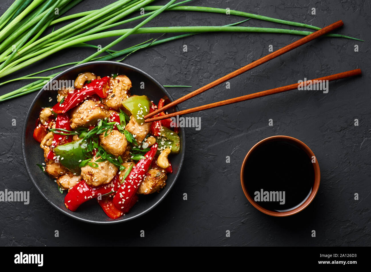 Schezwan Chicken or Dragon Chicken in black bowl at dark slate ...