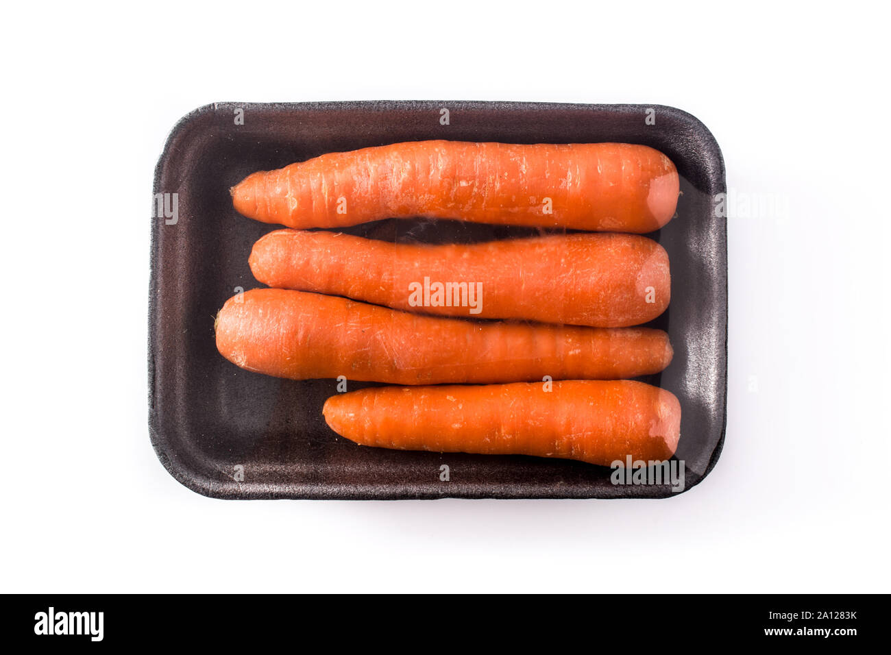 Carrots packaged in plastic isolated on white background. Top view ...