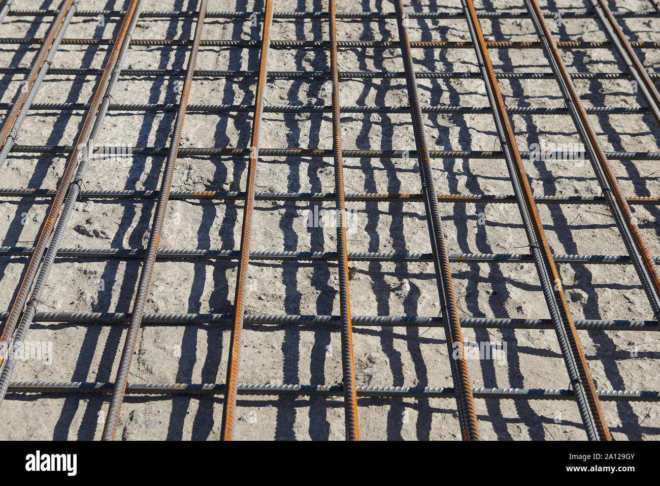 A lot of metal rods on concrete connected to each other. Bridge under ...
