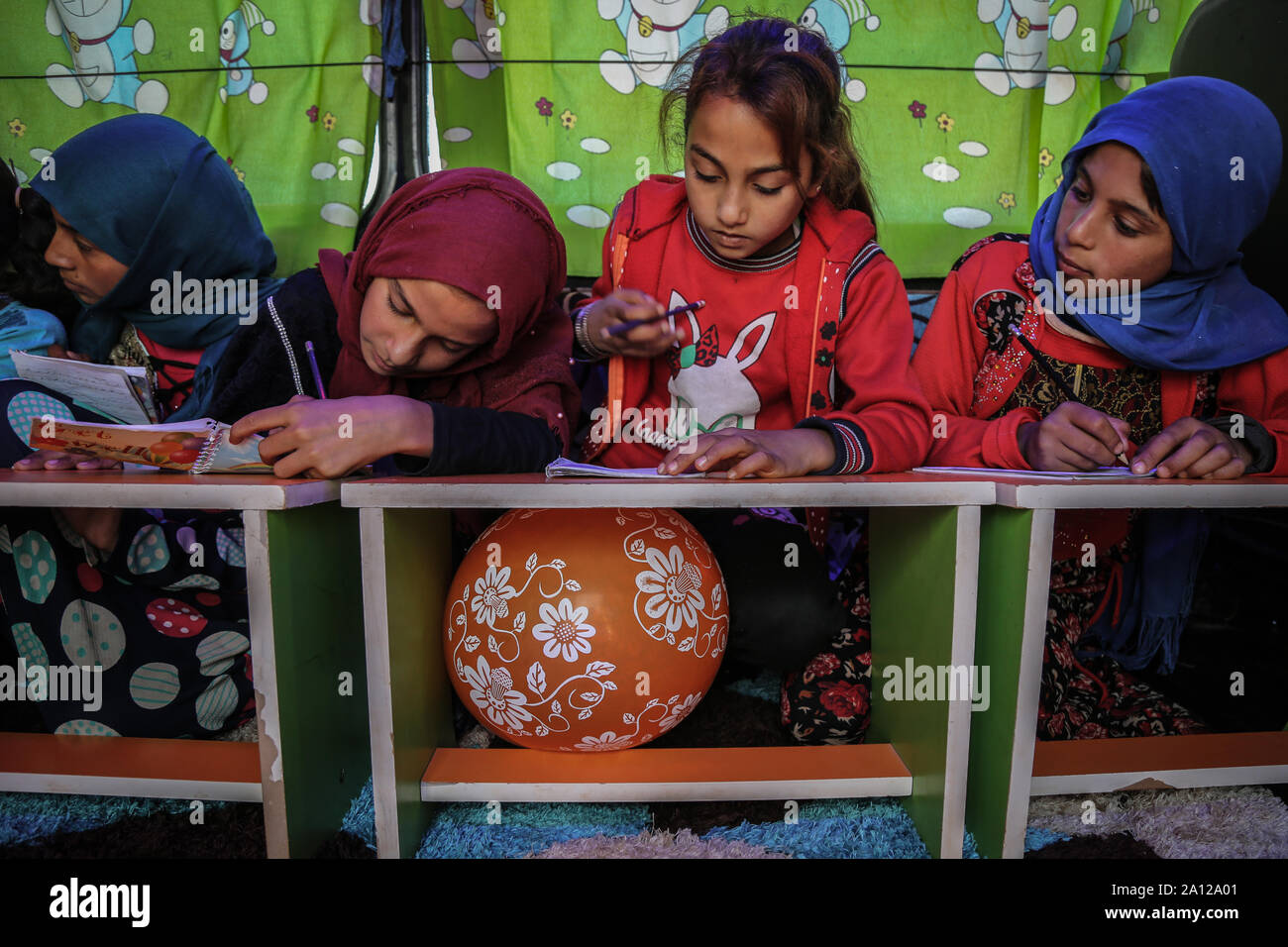 22 September 2019, Syria, Hazano: Syrian children study inside a bus ...