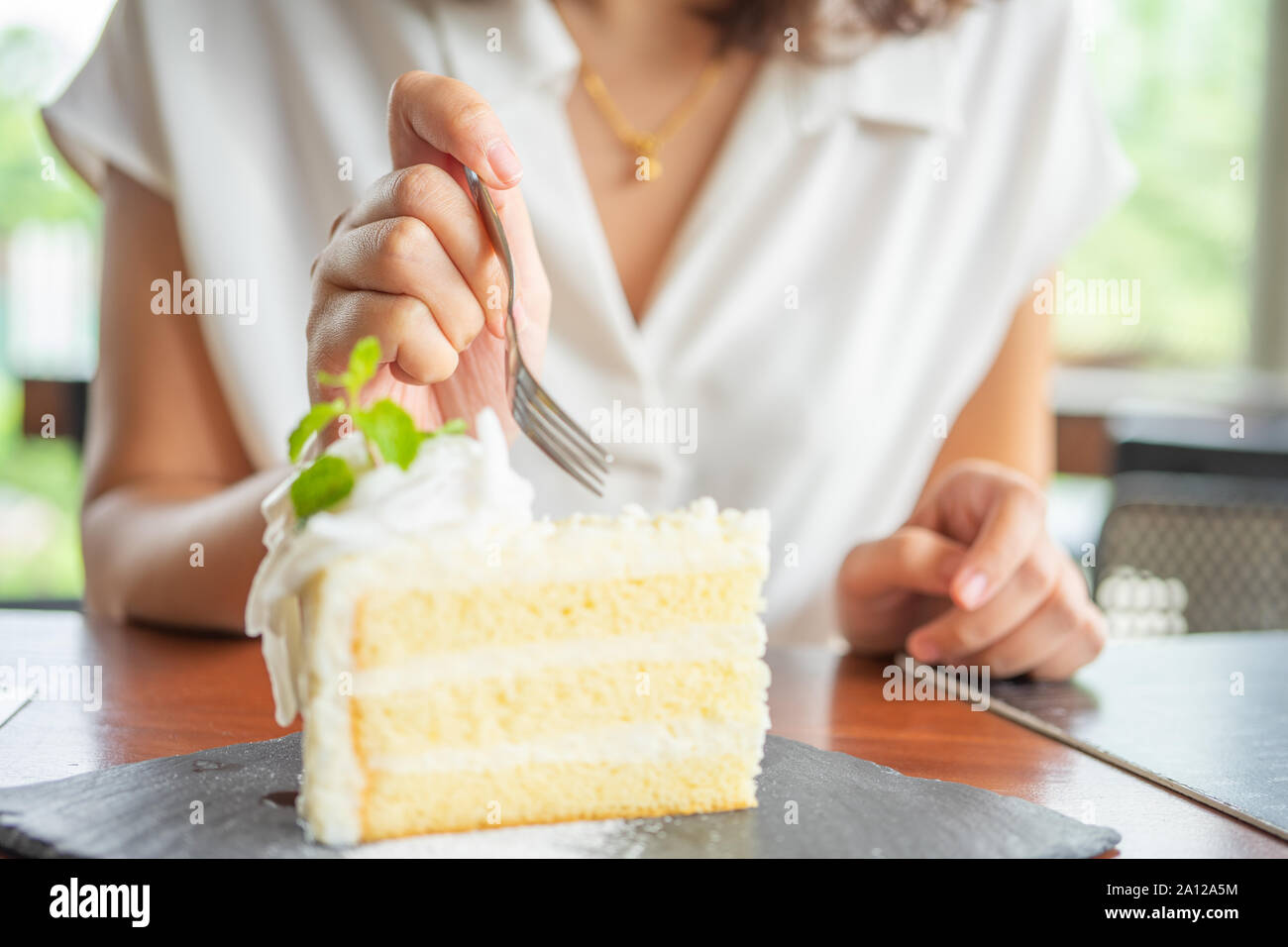 Asian beauty Scooping the cake to eat In Caffe Holiday idea Eating ...