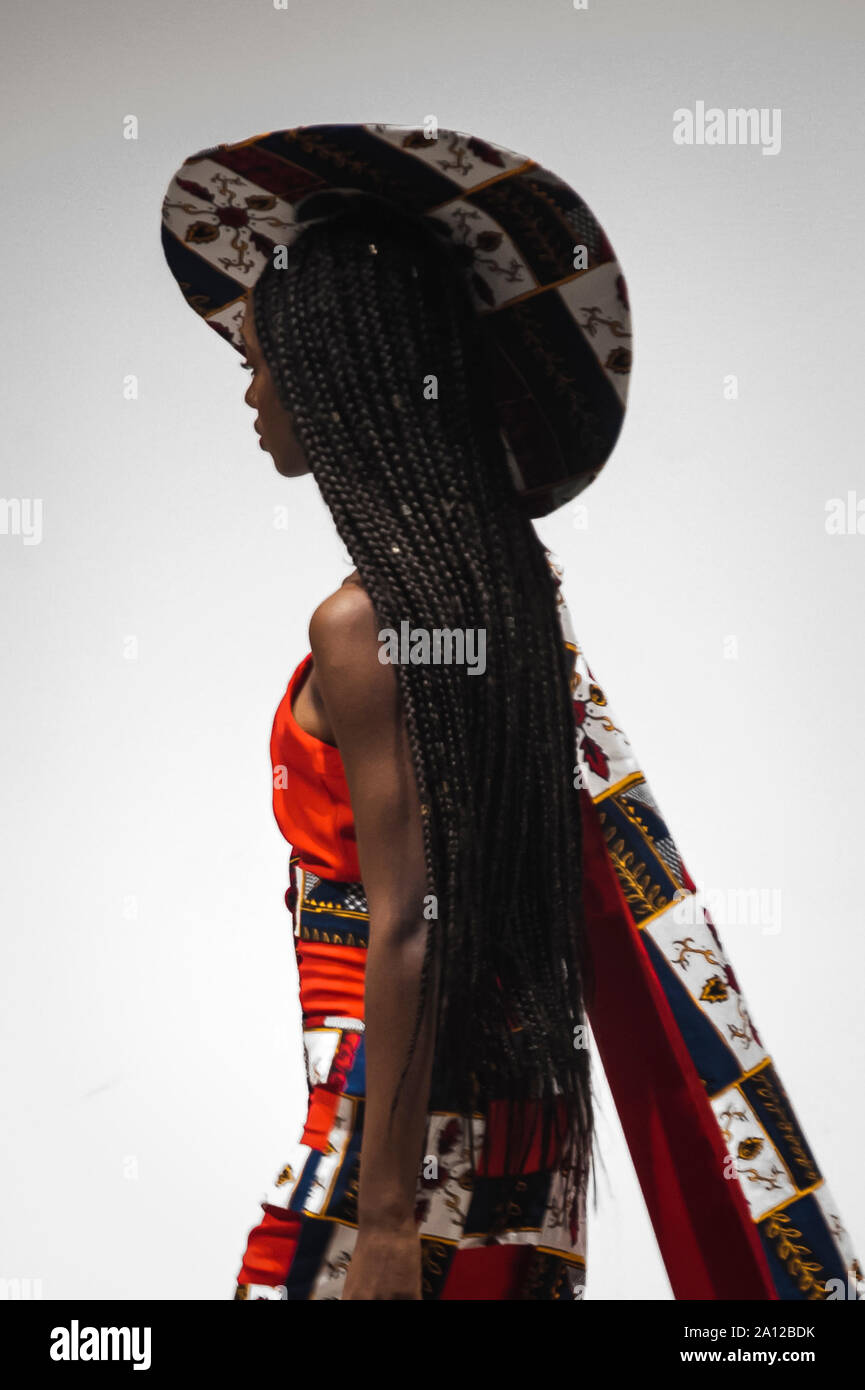 A model showcases a fashion design for Djuidje Couture during the event ...