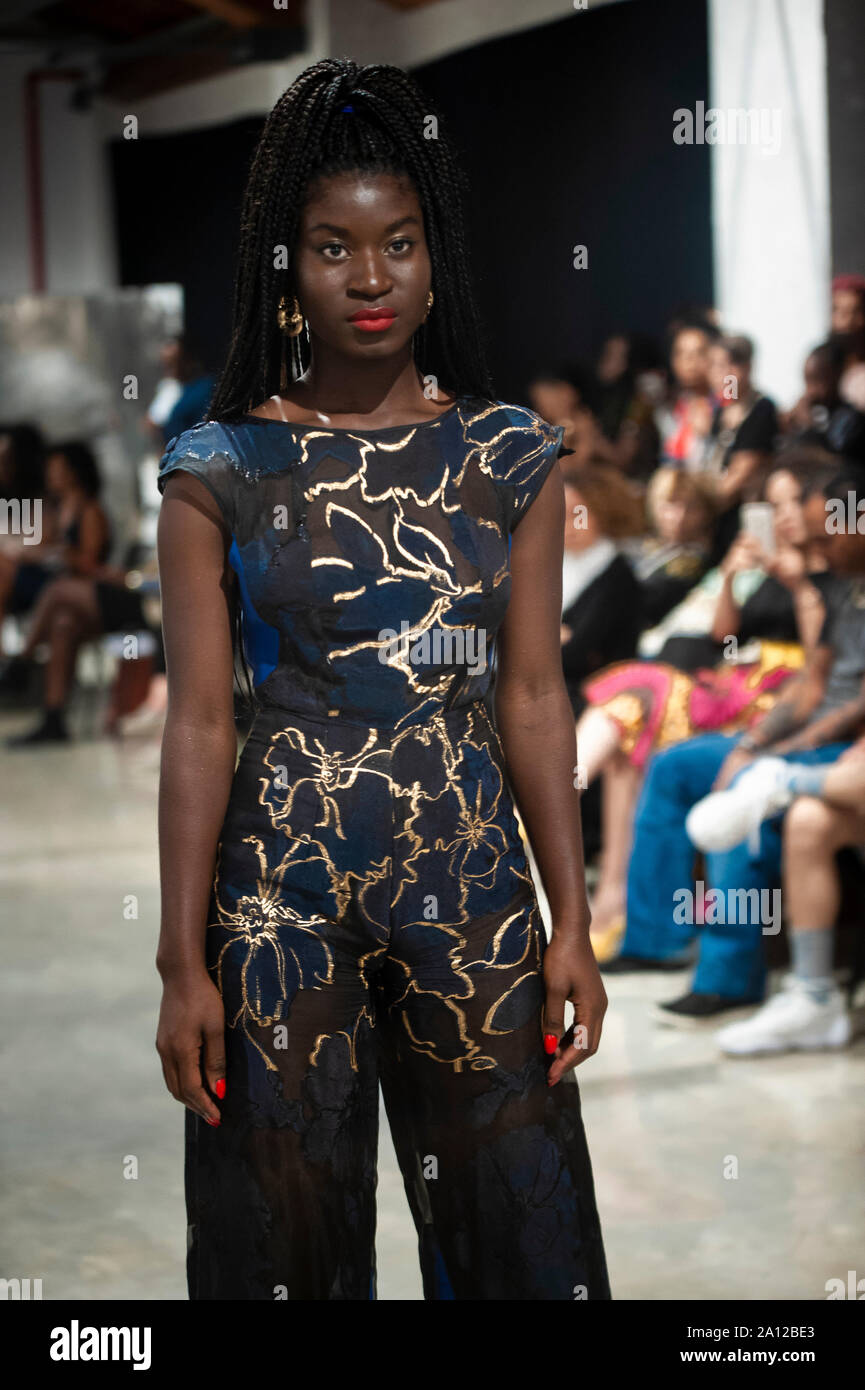 A model showcases a fashion design for Djuidje Couture during the event ...