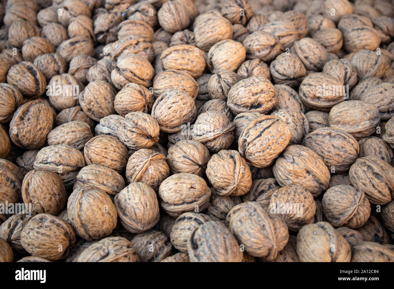 Walnuts background, texture. Dried nuts whole with shell on market ...
