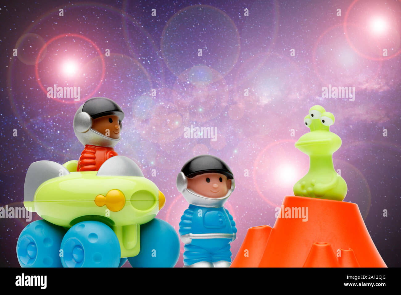 Two toy spacemen meeting an alien with a stary sky in the backgound ...