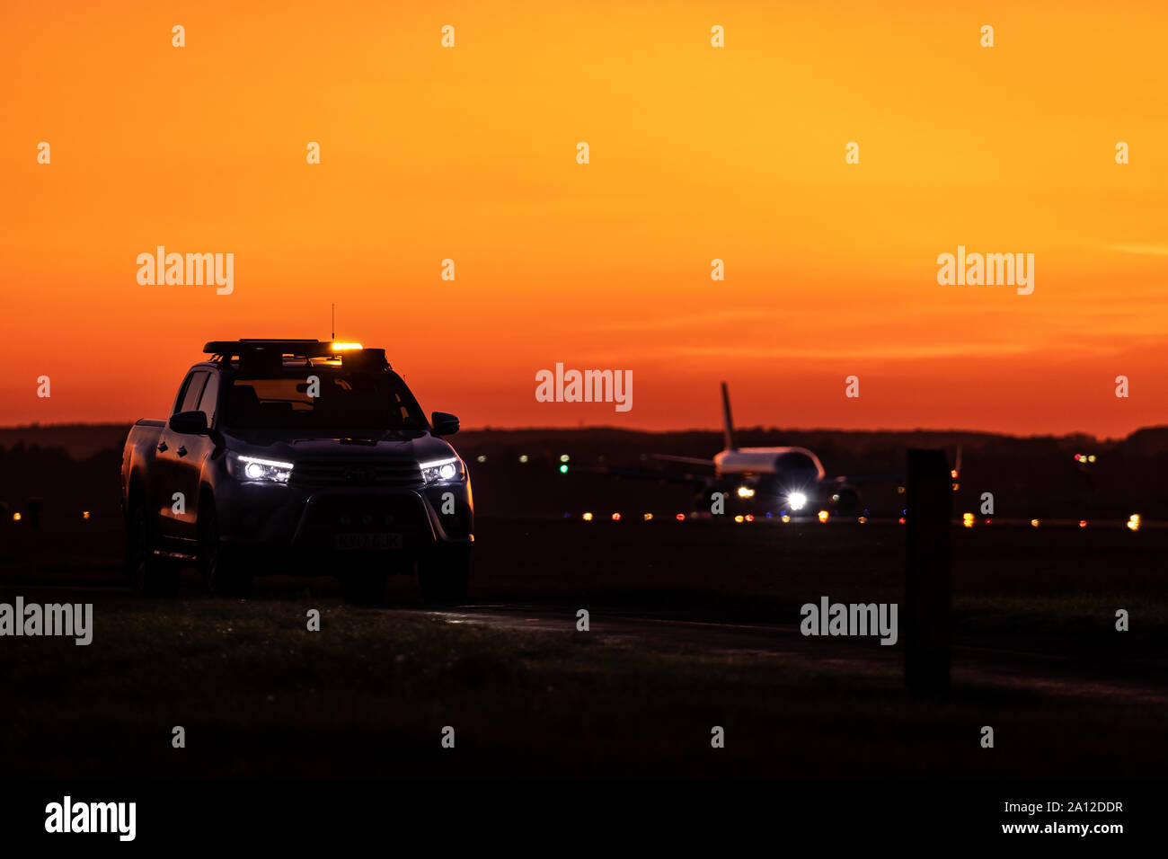 Airport operations vehicle driving along the perimeter road as an ...