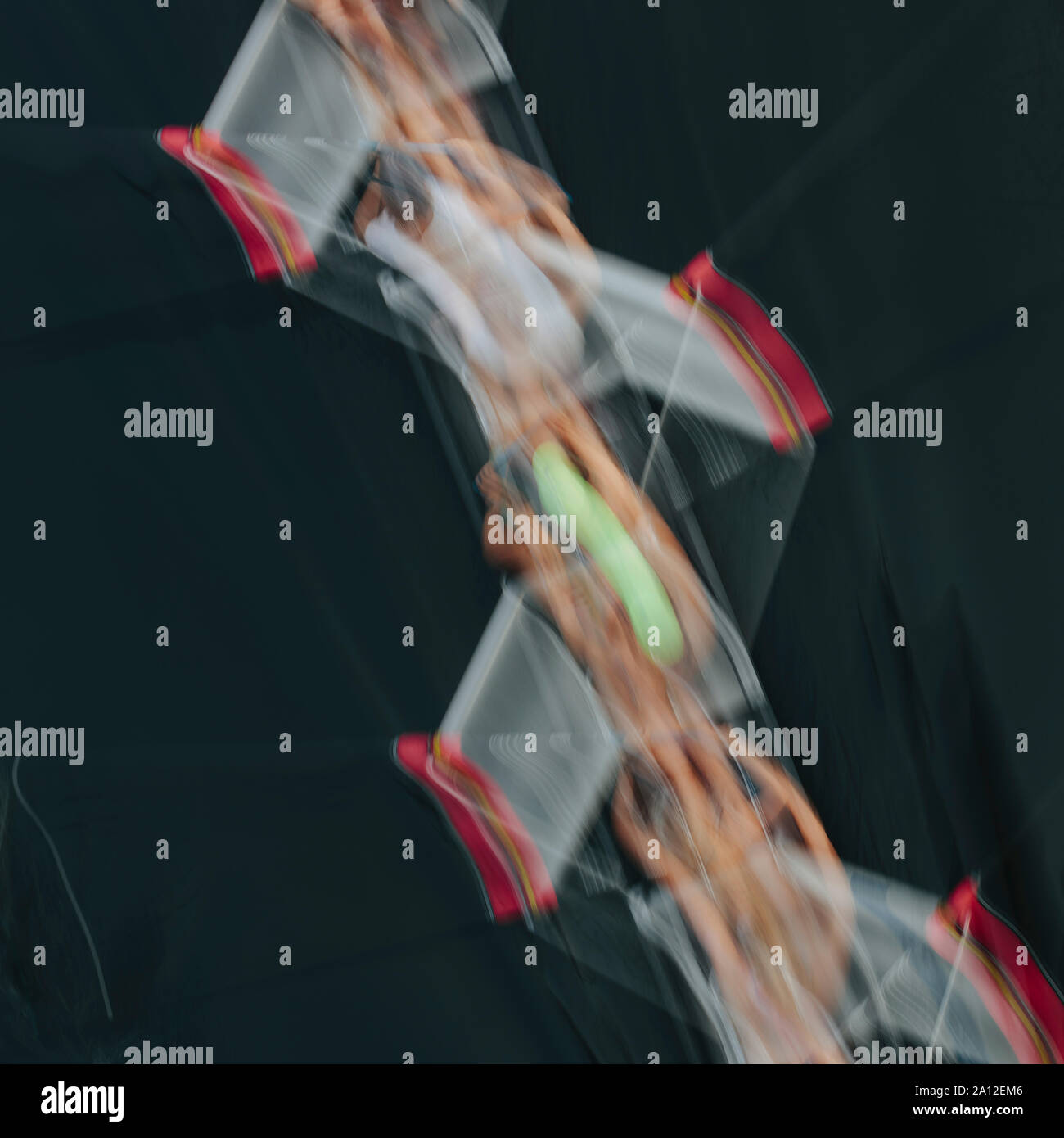 Blurred motion overhead view of a rowing crew in a sculling boat on the ...