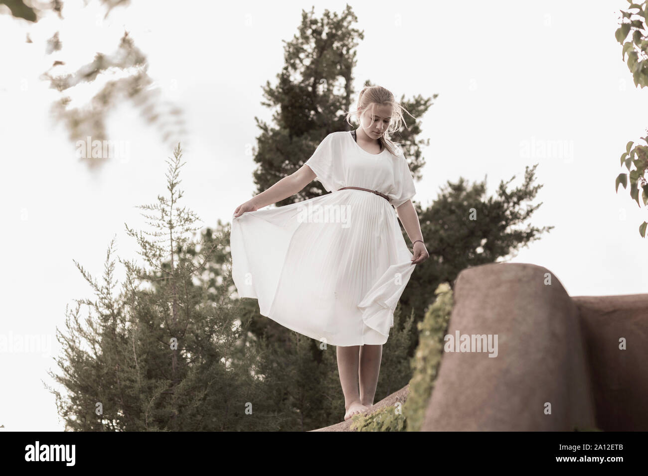 13 year old girl balancing on adobe wall Stock Photo - Alamy