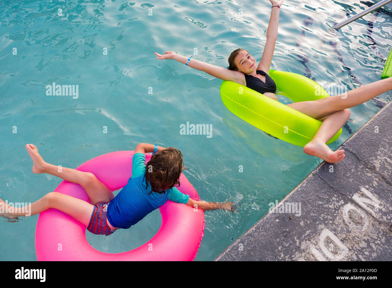 Brother sister playing in pool hi-res stock photography and images - Alamy