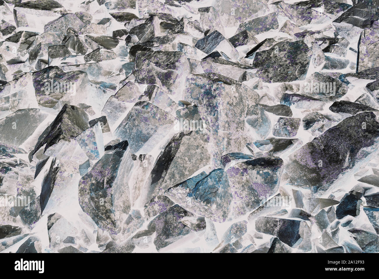 Abstract (inverted) image of pile of large granite boulders and rocks ...