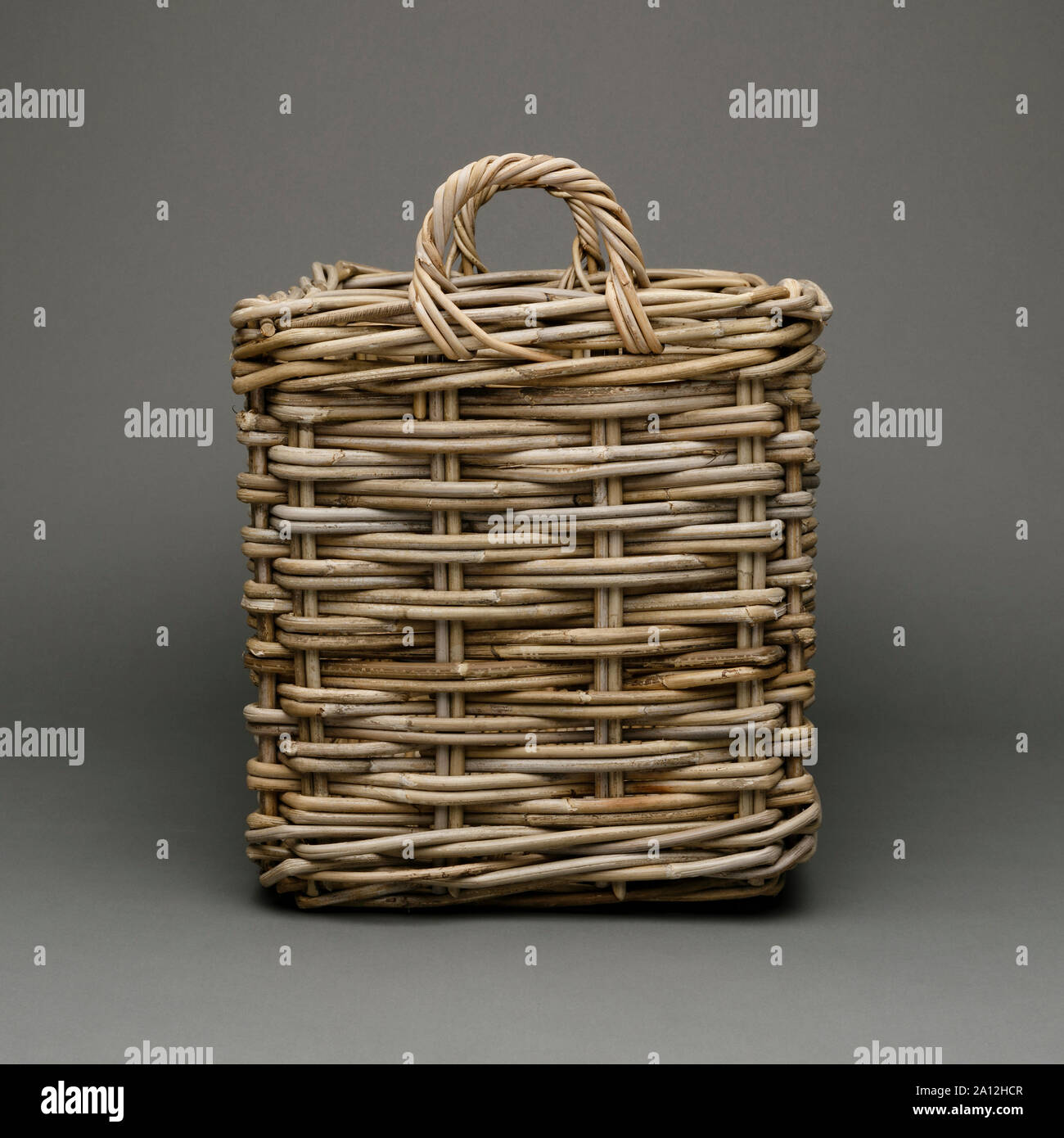 Individual natural wicker basket, with a grey background, and a drop ...