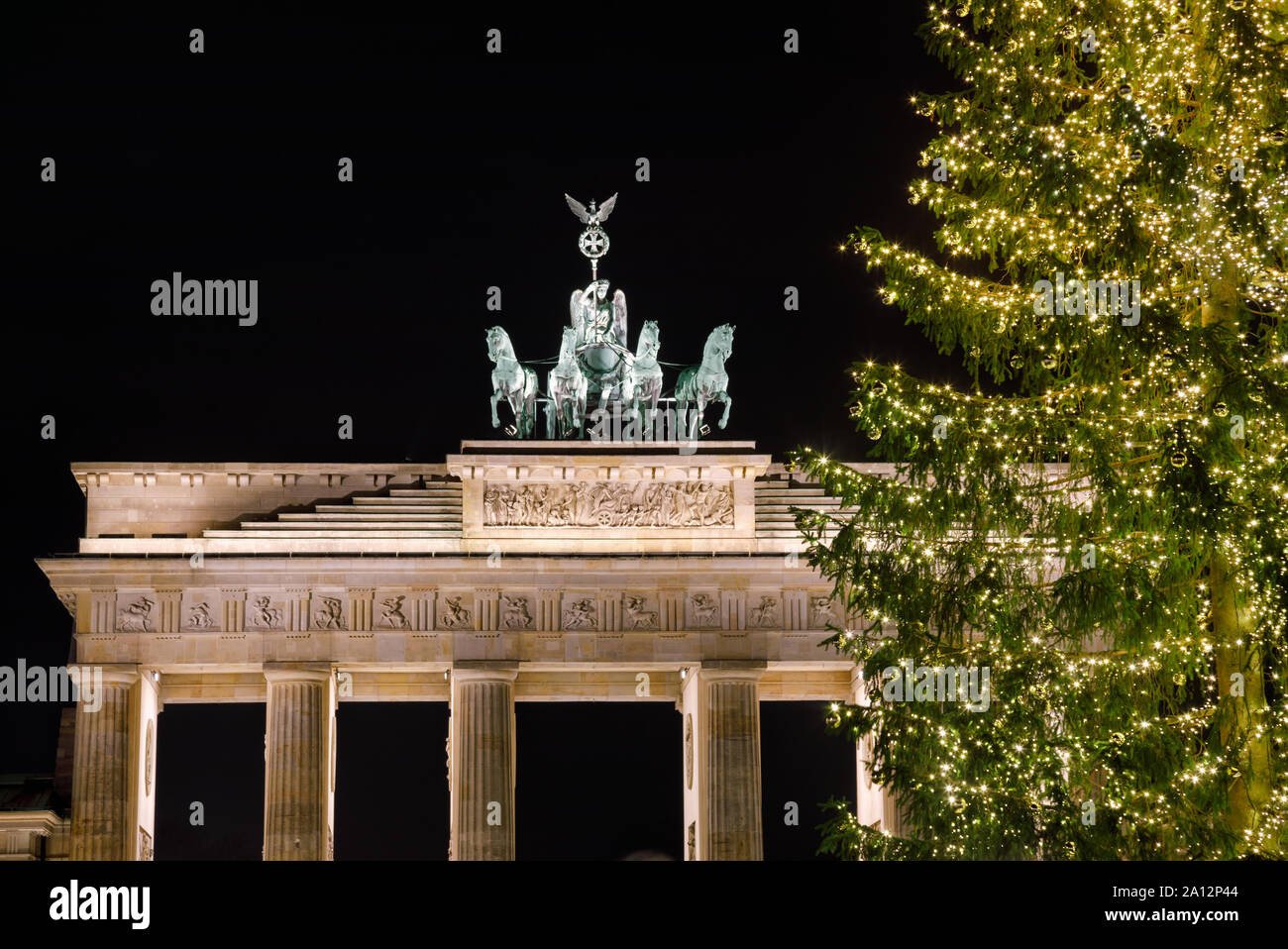 Illuminated Neoclassical Brandenburg Gate (Brandenburger Tor) and Christmas Tree as viewed from ...