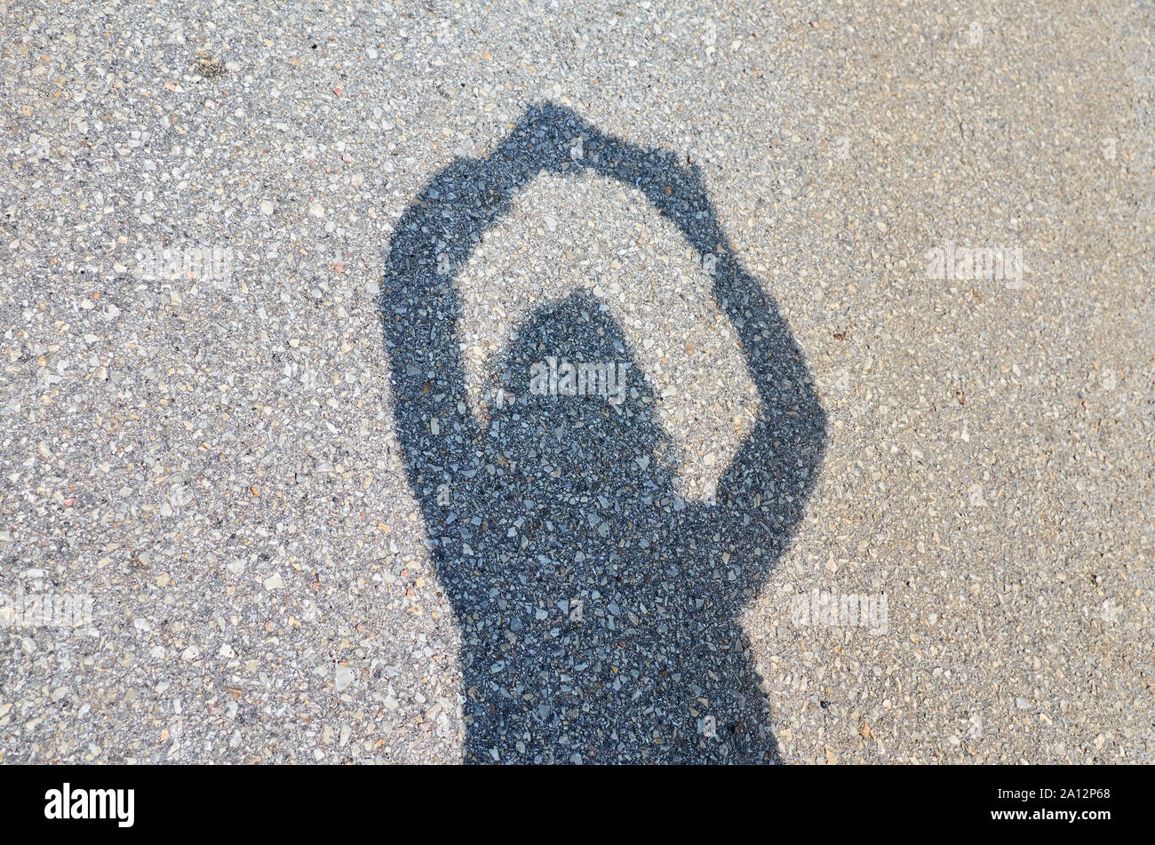 Shadow of a woman while taking a selfie, on an asphalt background Stock ...