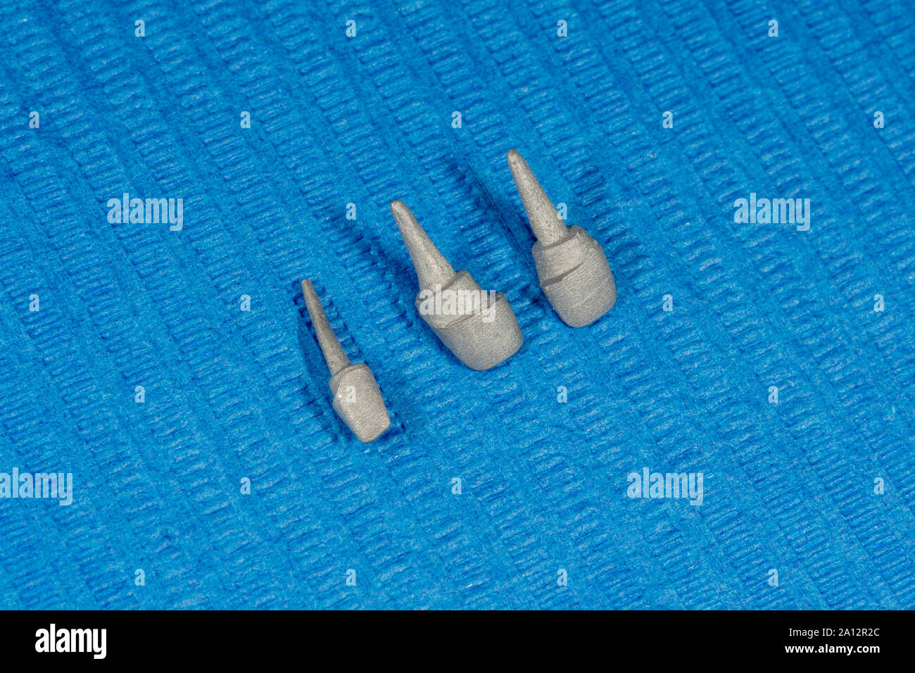 metal cast pin of a human tooth on a gypsum model close-up in dental ...