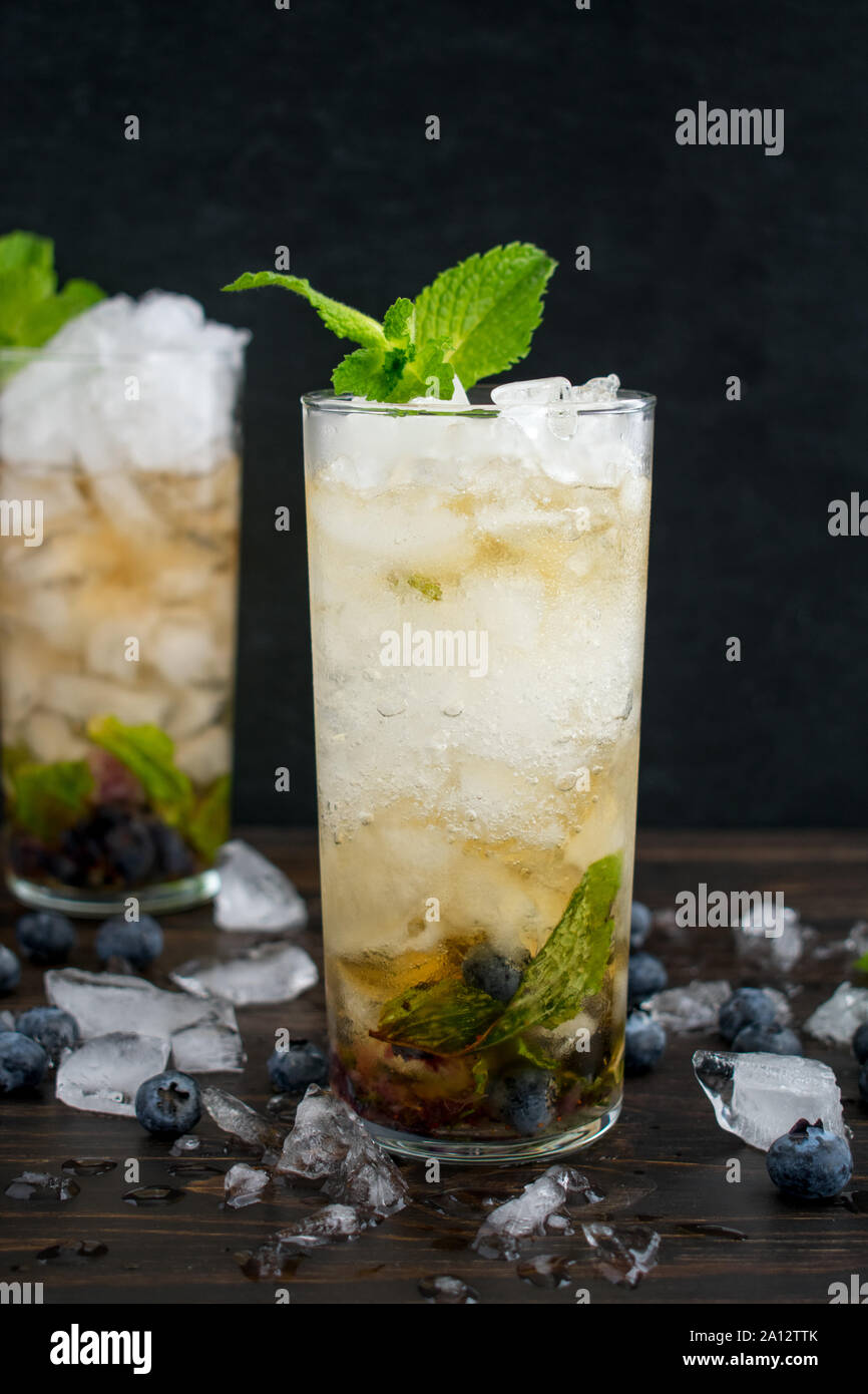 Blueberry Mint Julep Cocktails with Garnish: Two cocktails made with ...