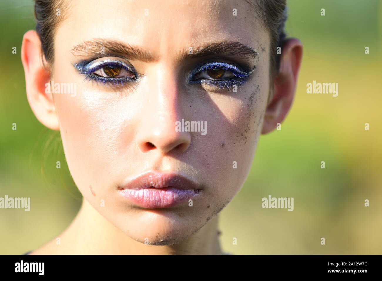 Young woman with sand on skin, beauty. Make up, color cosmetics, visage ...