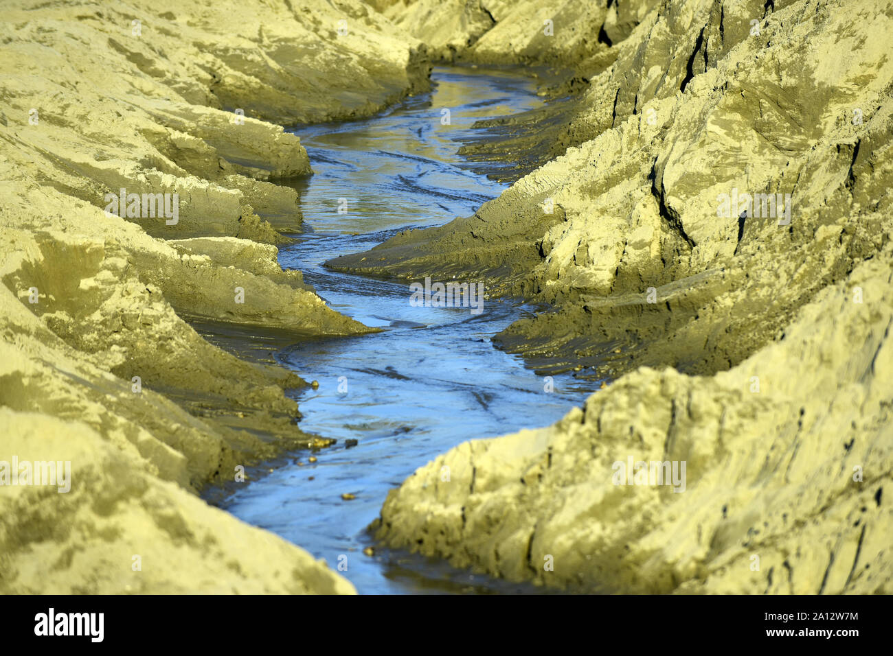 Water stream in sand. Water flow on sandy landscape. River, canyon ...