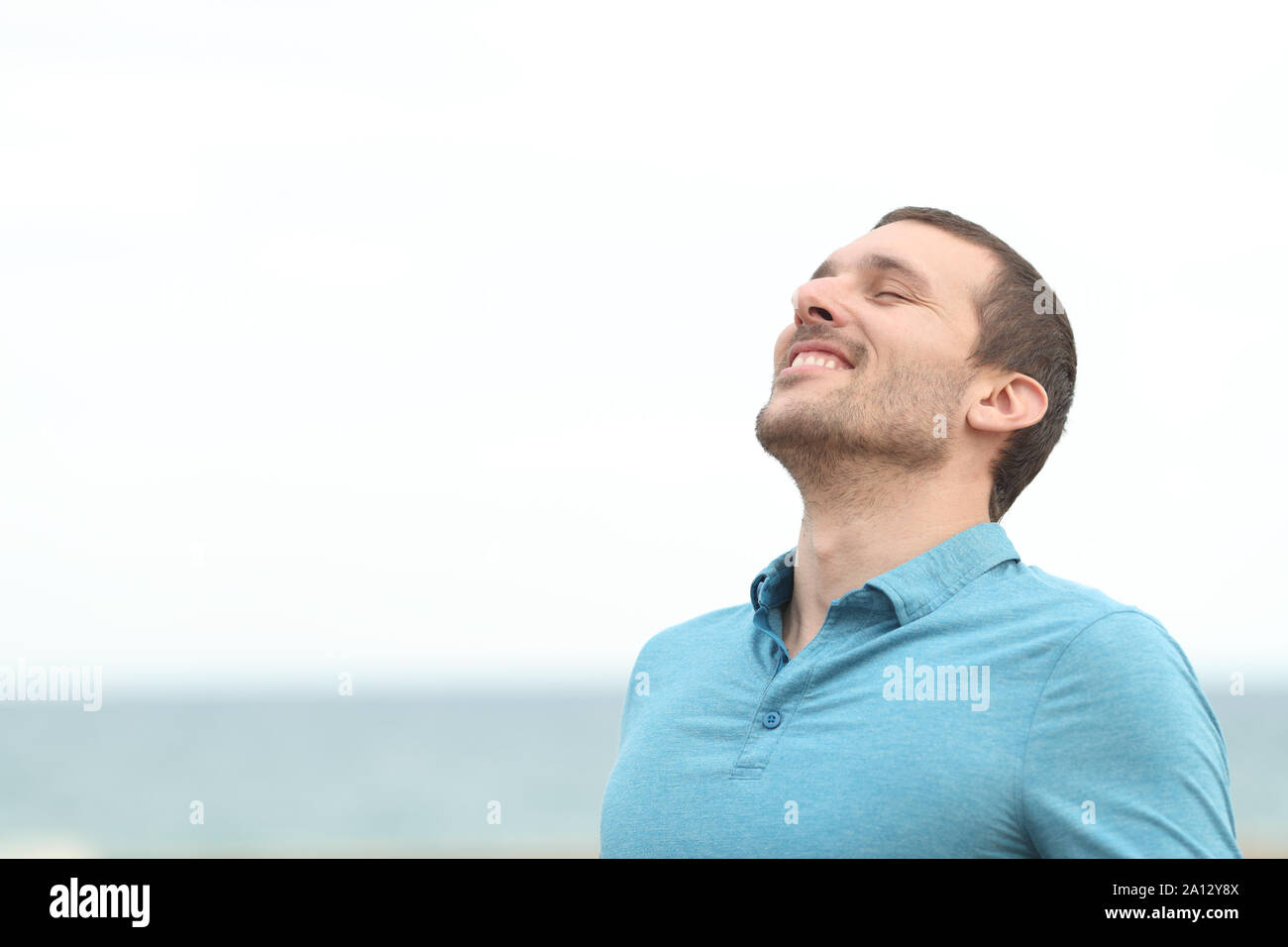 Handsome adult casual man breathing deeply fresh air on the beach Stock ...