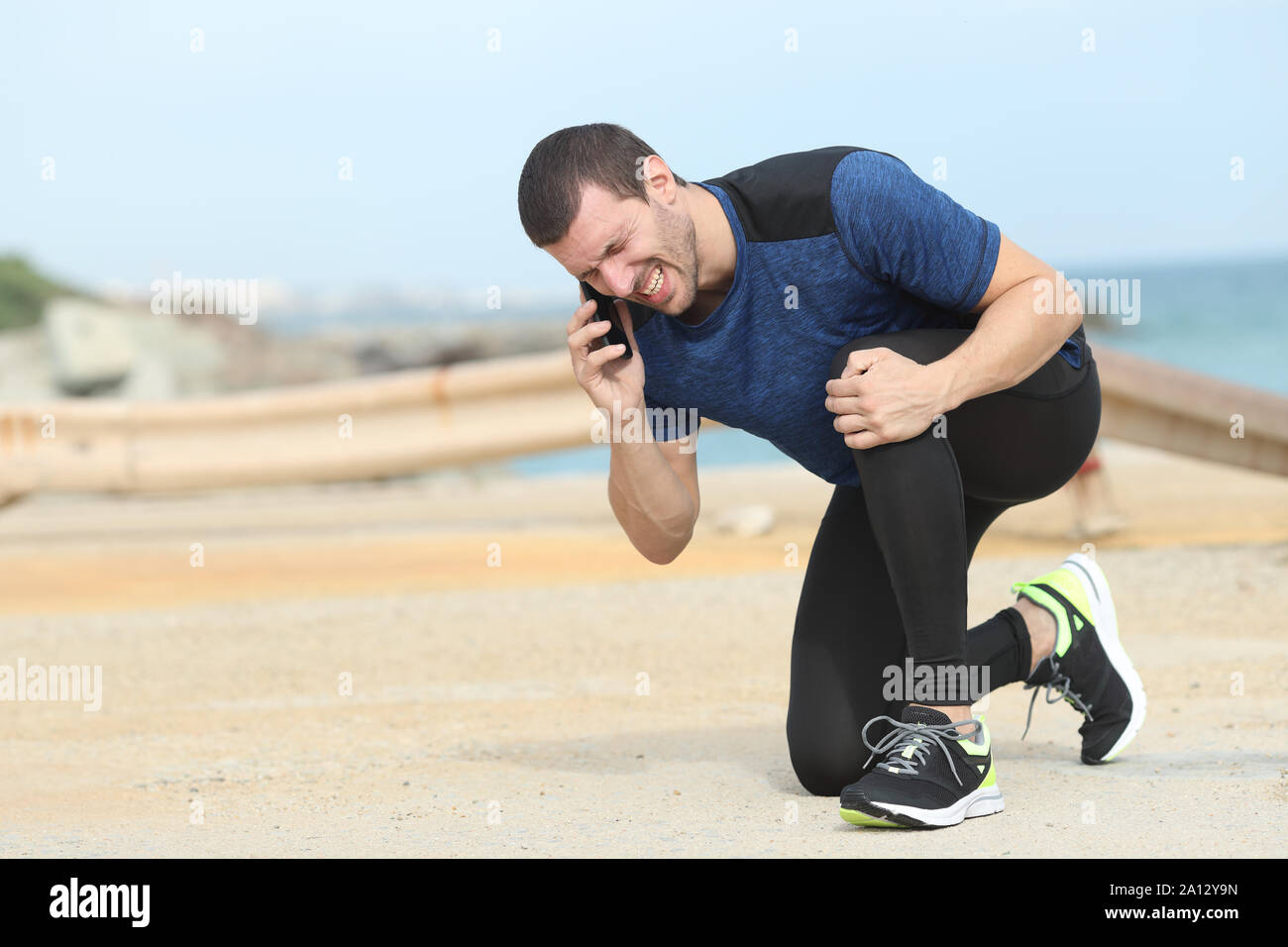 Painful runner suffering knee ache asking for help calling on phone ...