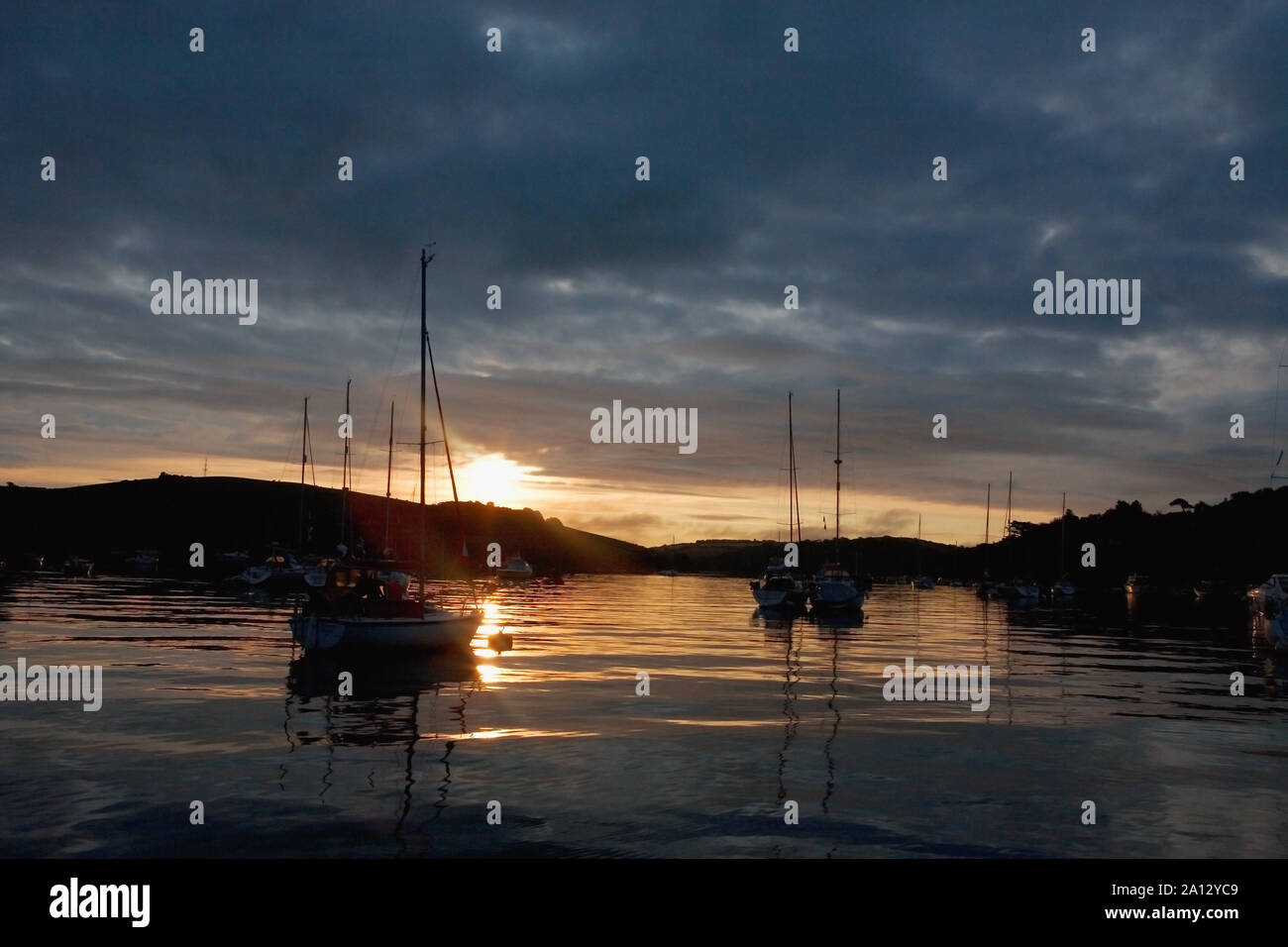 Cloudy dawn over Salcombe harbour, Devon, UK: calm sea and yachts at ...
