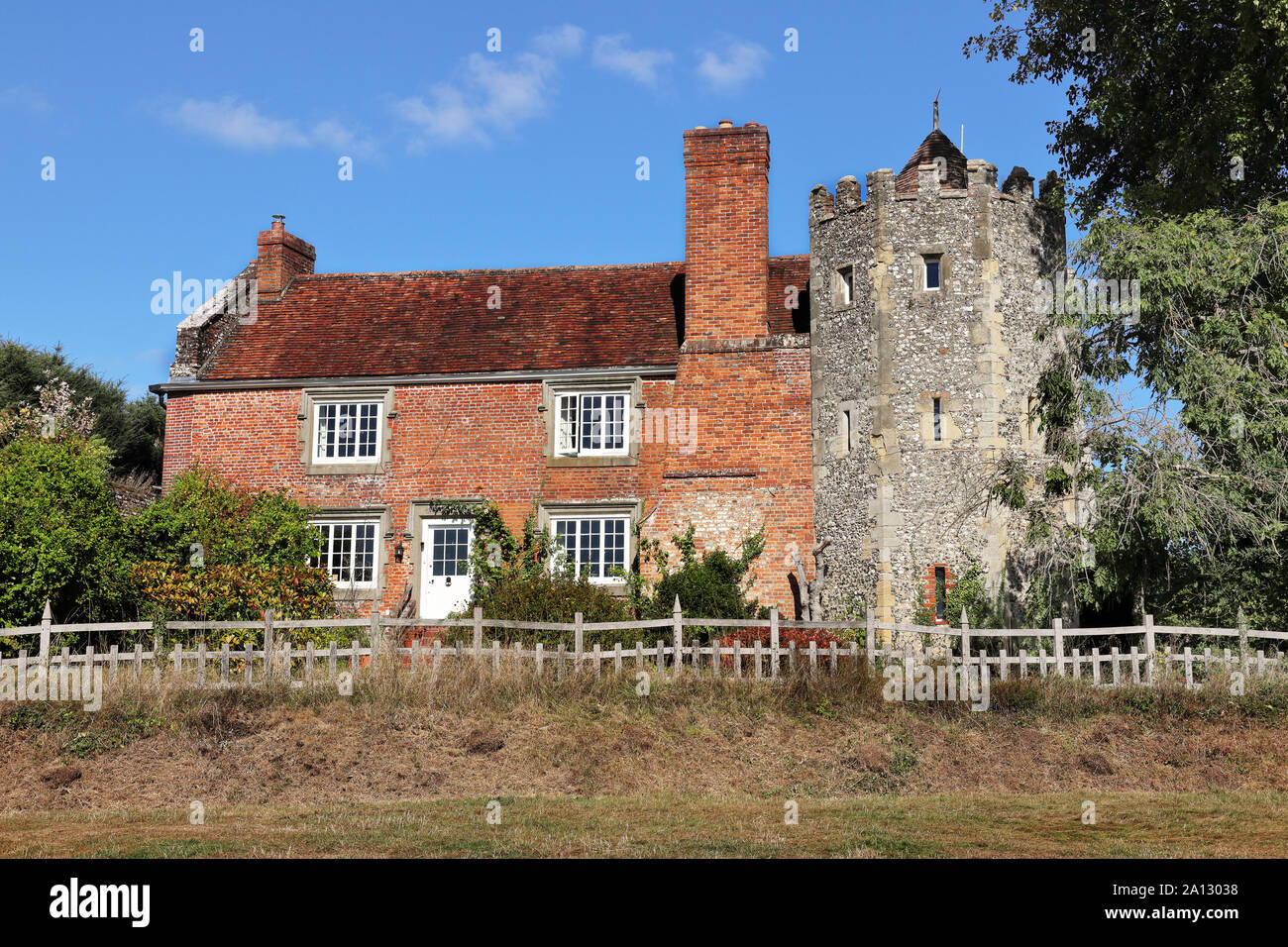 Medieval red brick English House and garden and tower Stock Photo - Alamy