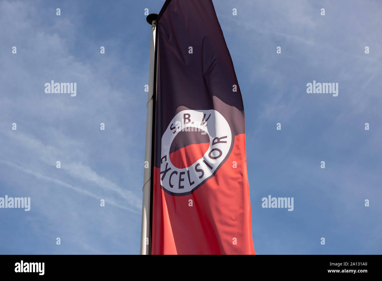 Flag with symbol of the Dutch soccer club Excelsior blowing in the wind ...