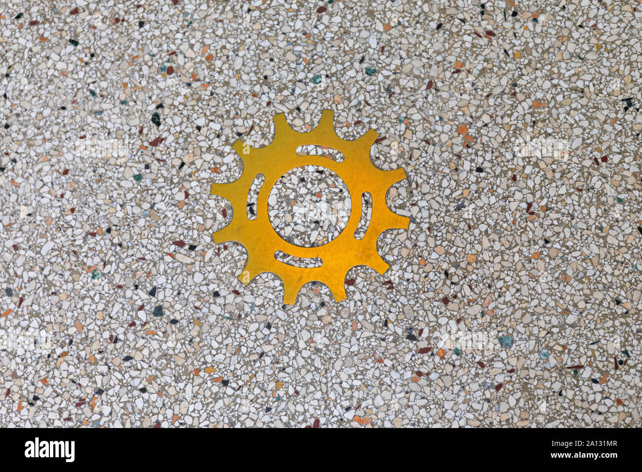 One Brass Cog Gear Part at Floor Stock Photo - Alamy