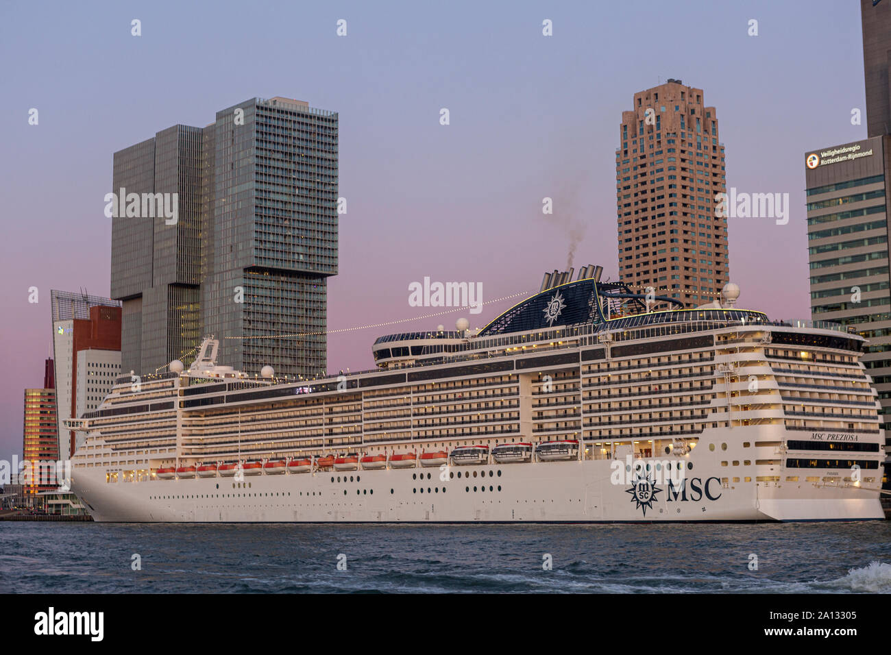 Cruise ship MSC Preziosa in front of the iconic Dutch port city skyline ...