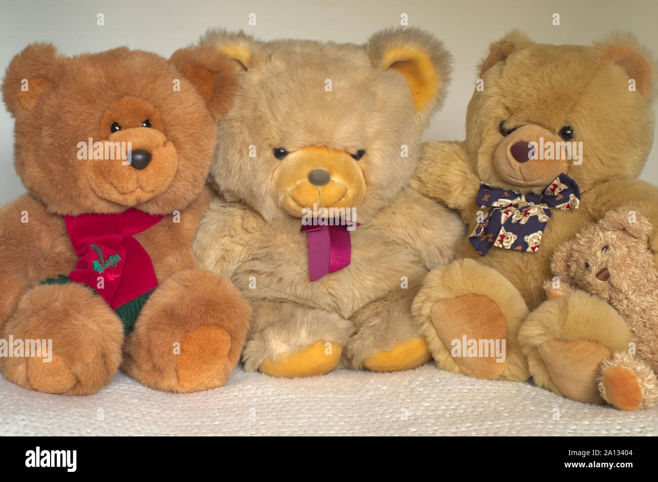 Four Teddies in a Row With Arms Around Each Other Stock Photo - Alamy