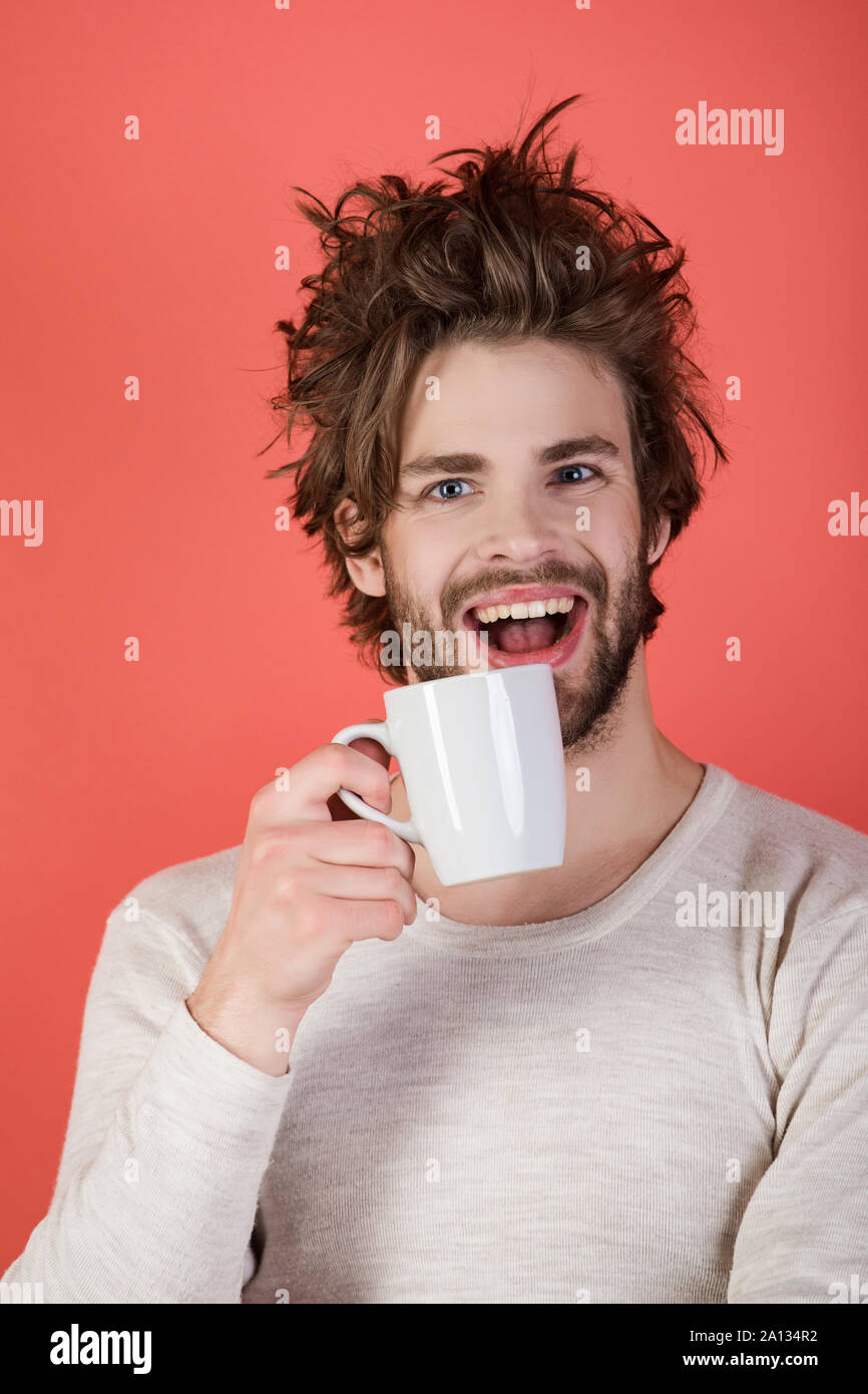 Morning with coffee or milk. Happy guy with tea cup on red background ...