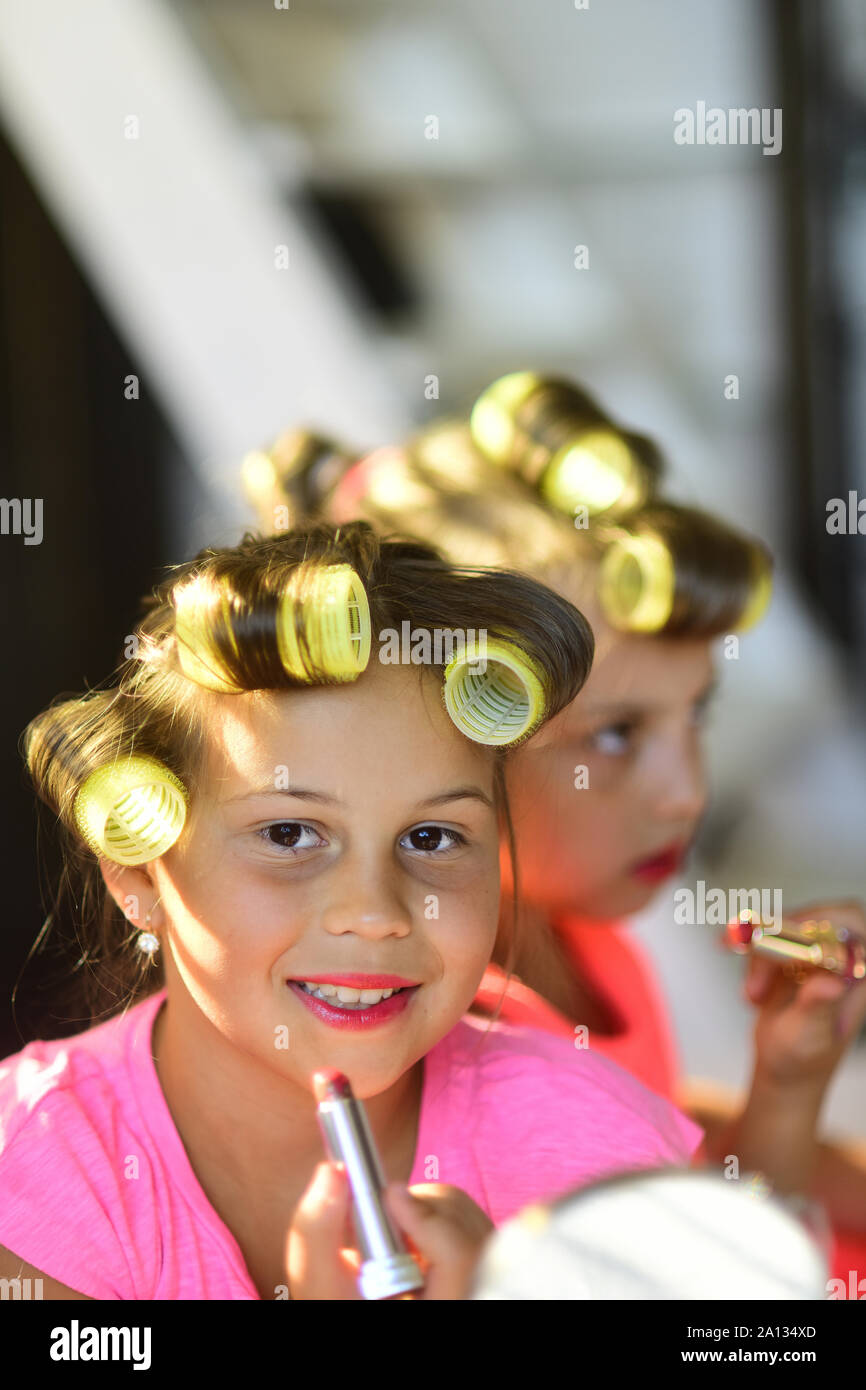Little girls do makeup sitting in room. Beauty and fashion concept ...