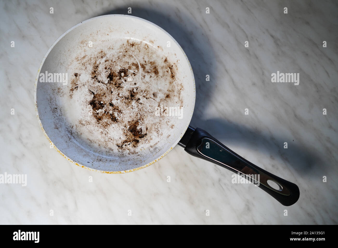 Dirty white frying pan Stock Photo - Alamy