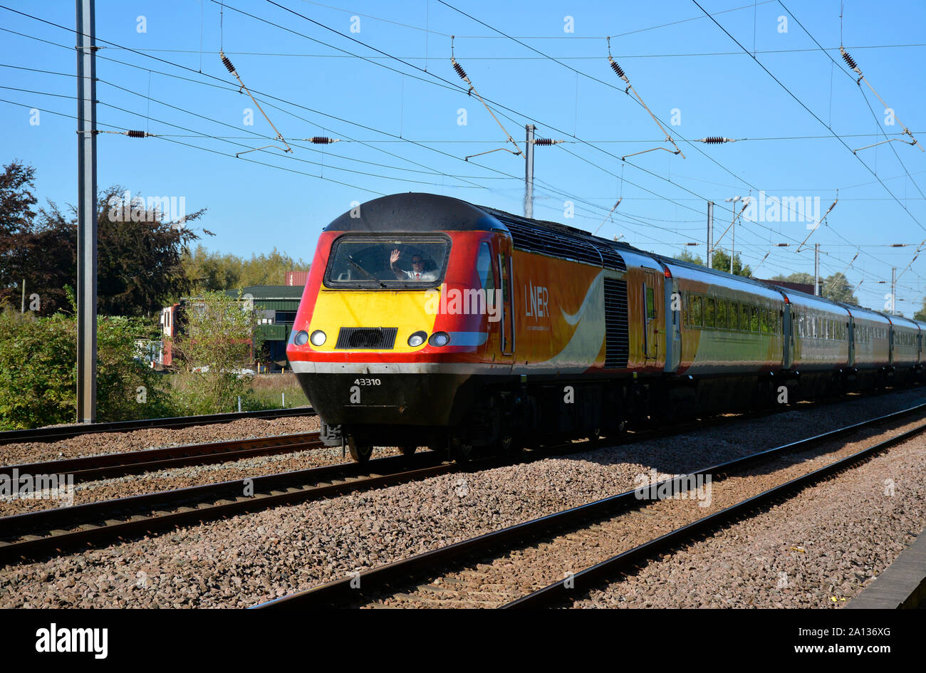 Driver waves as LNER Class 43 HST 43310 passes Offord Cluny on the East ...