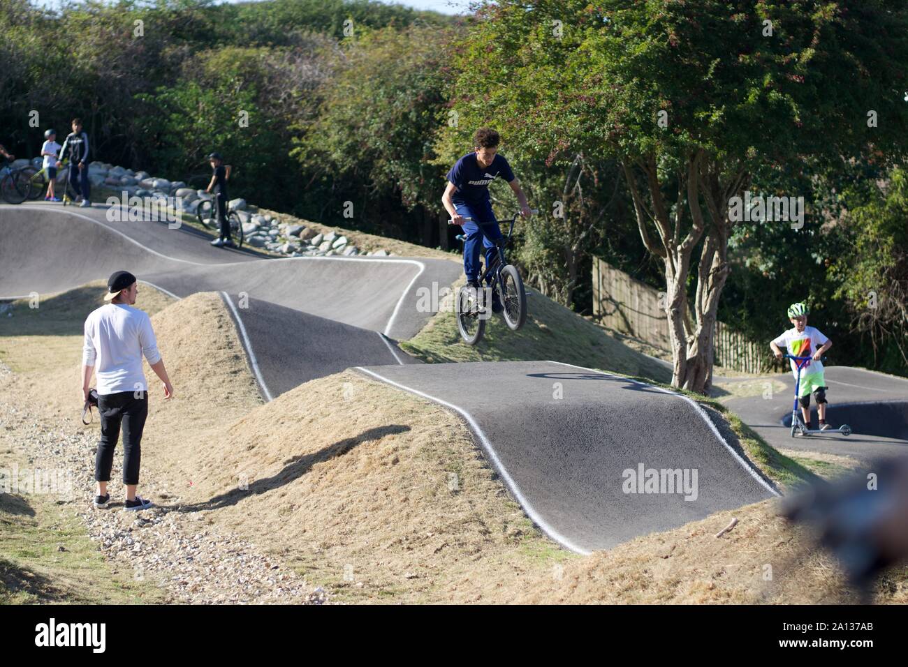 Kids riding on pump bike track Stock Photo - Alamy