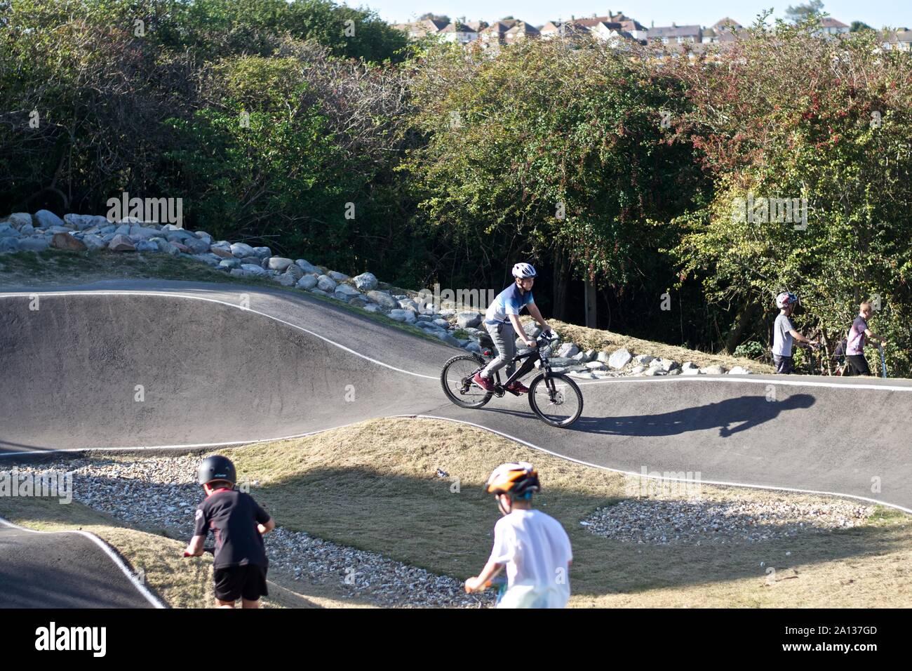 Kids riding on pump bike track Stock Photo - Alamy
